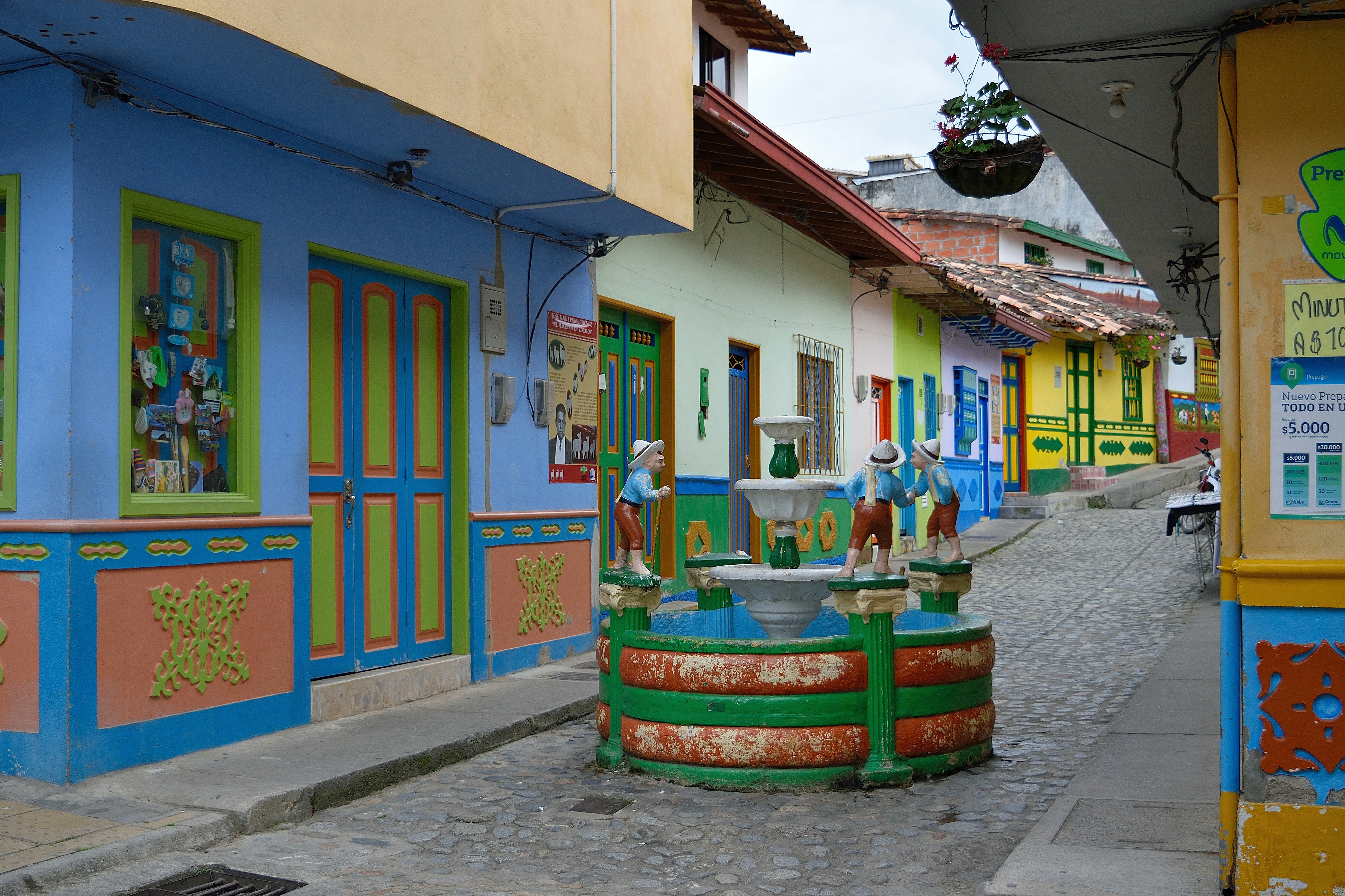 Colorful Cobblestones and a Central Fountain: A Quiet Alley of Painted Houses