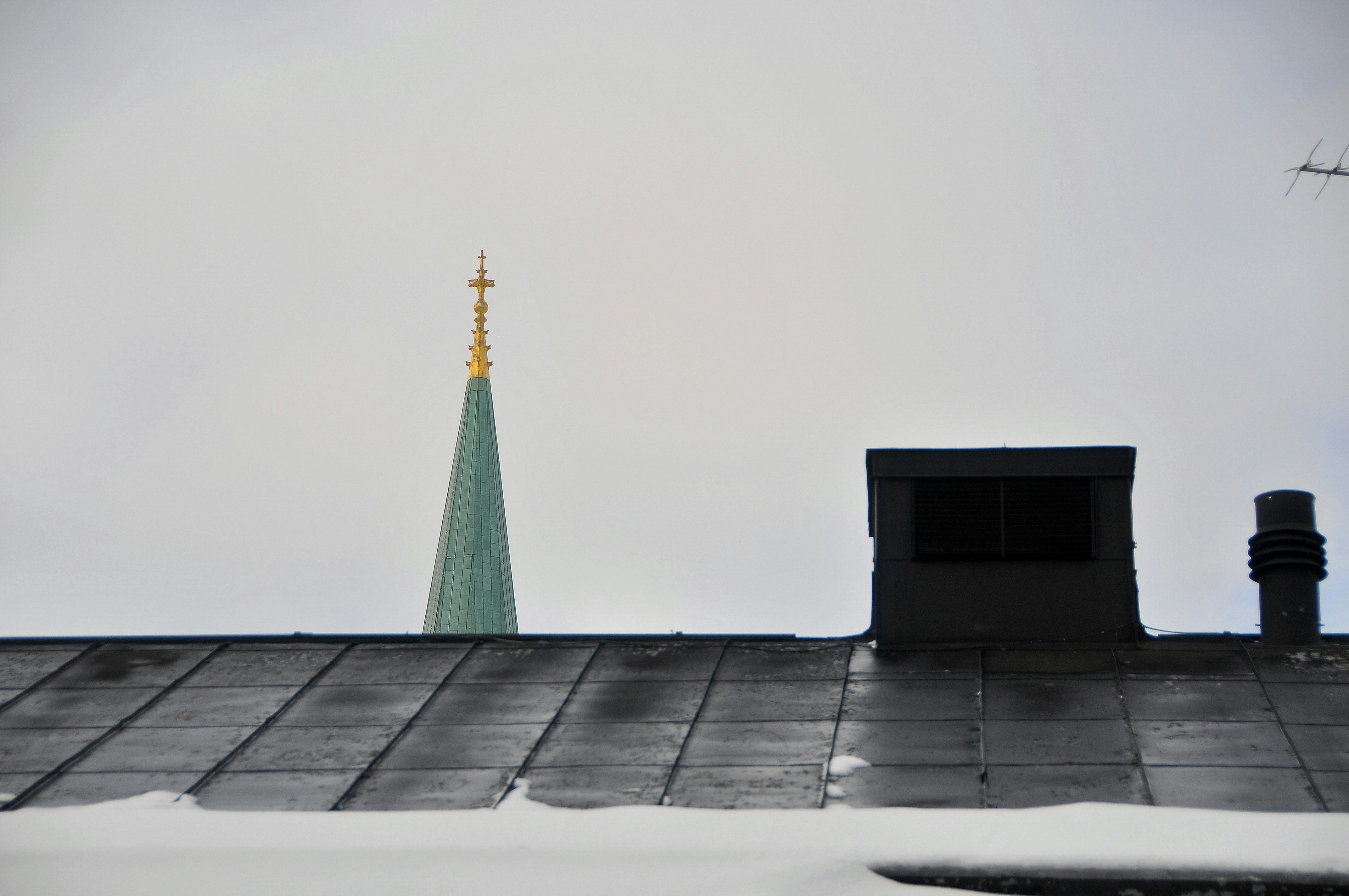 Golden Spire Above a Slate Roof
