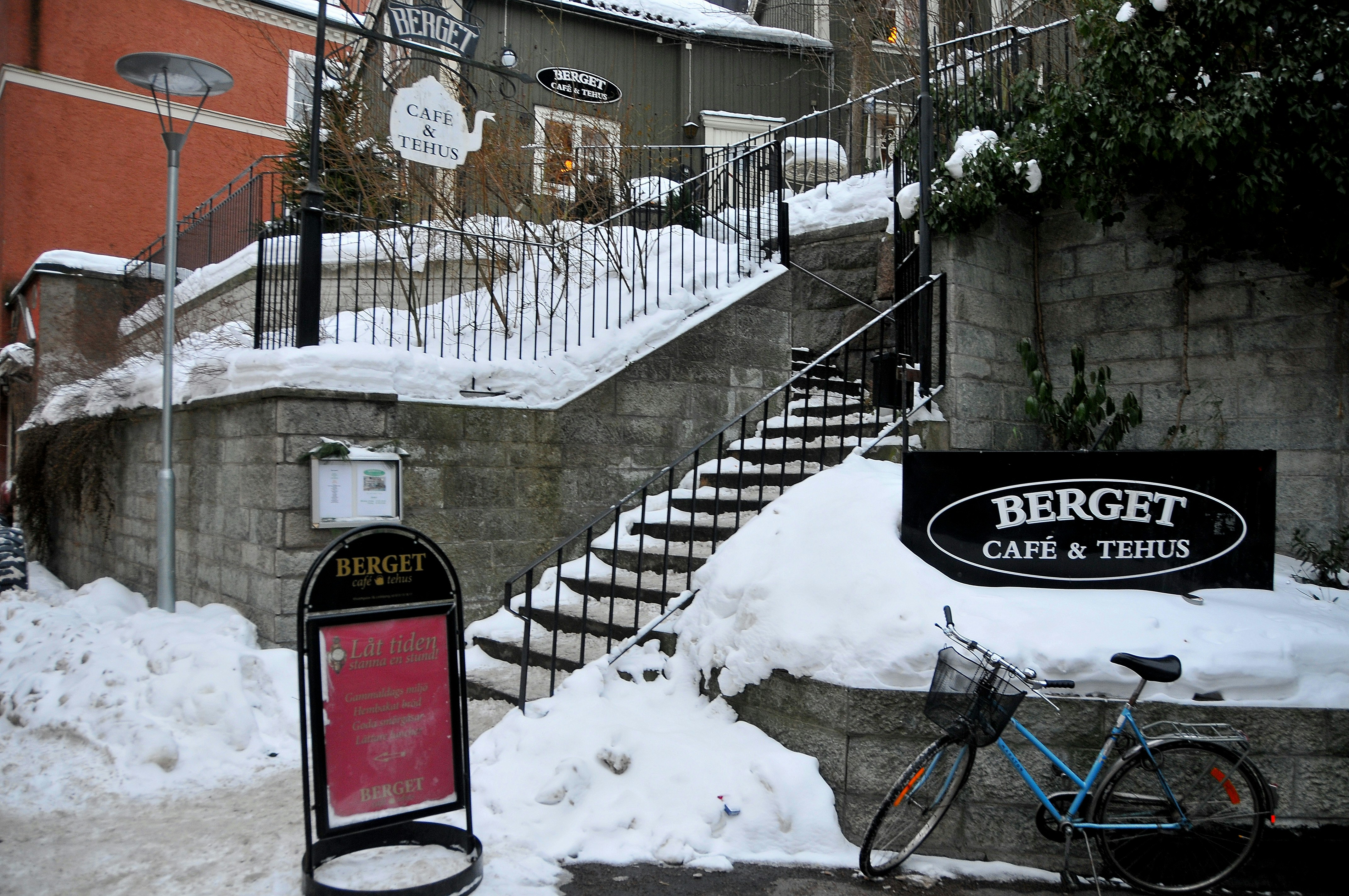 Snow-Covered Steps to Bergart Café on a Nordic Street
