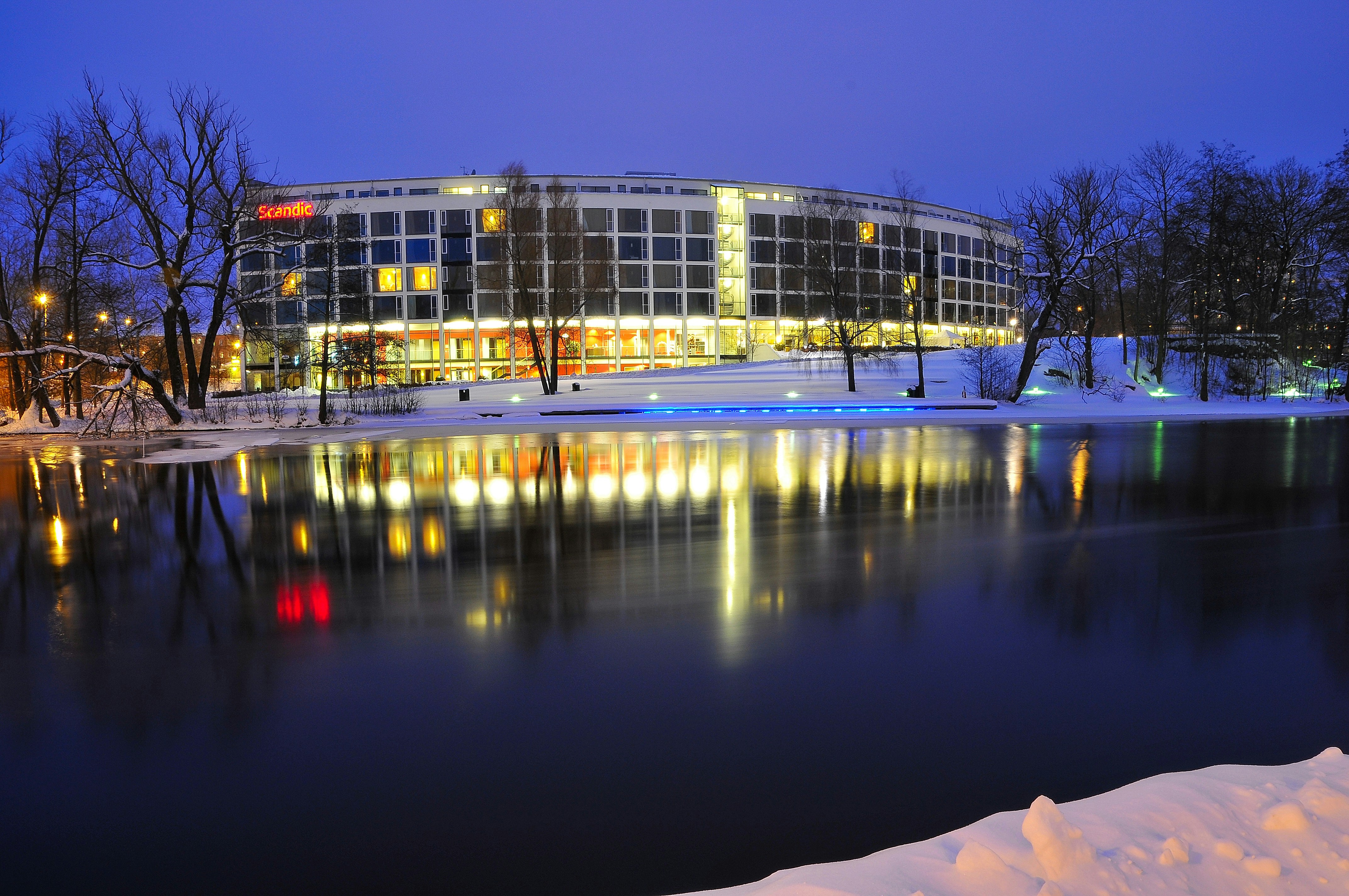 Glass Facade at Dusk Across a Snowlit River