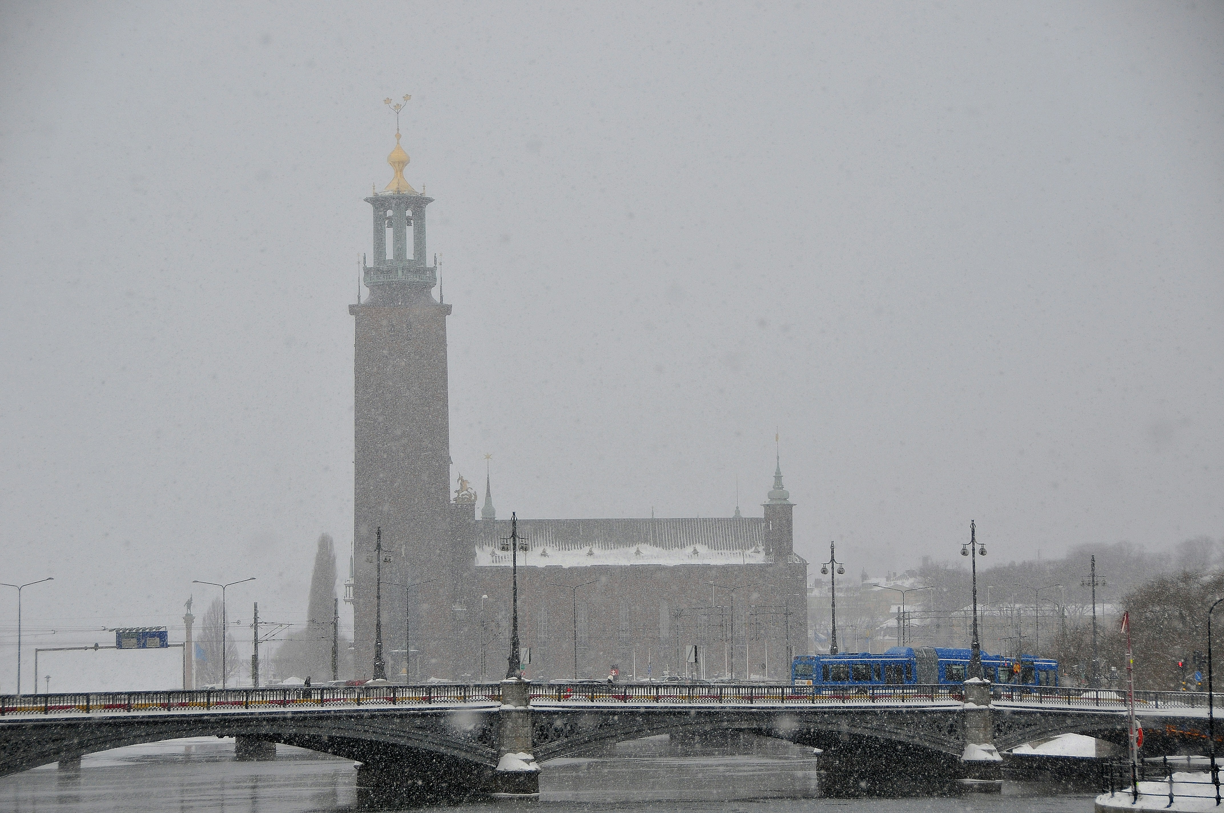 Snowfall over a historic riverside hall: a quiet winter silhouette