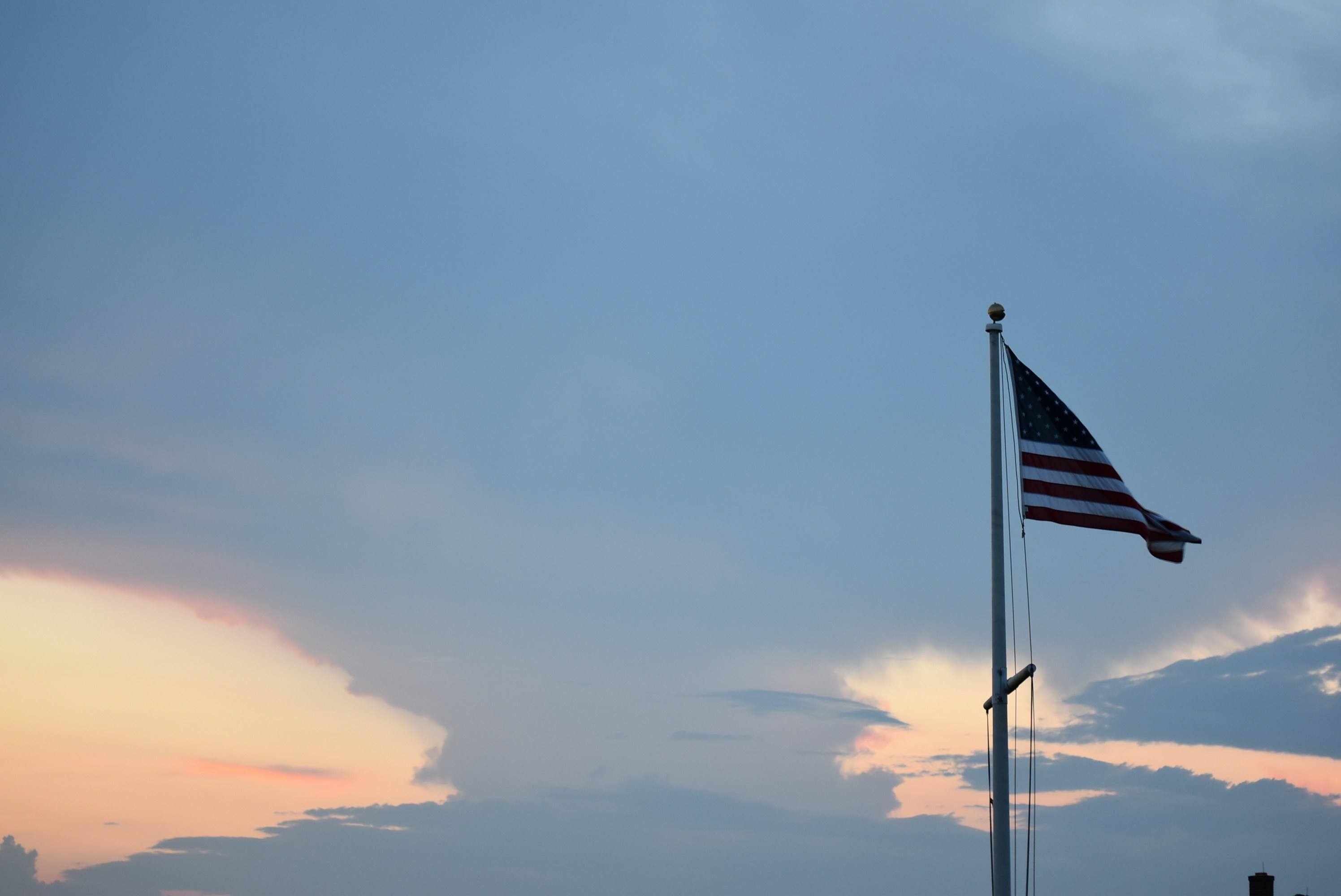 Flagpole Quiet: Sunset Light on the Lone Ensign