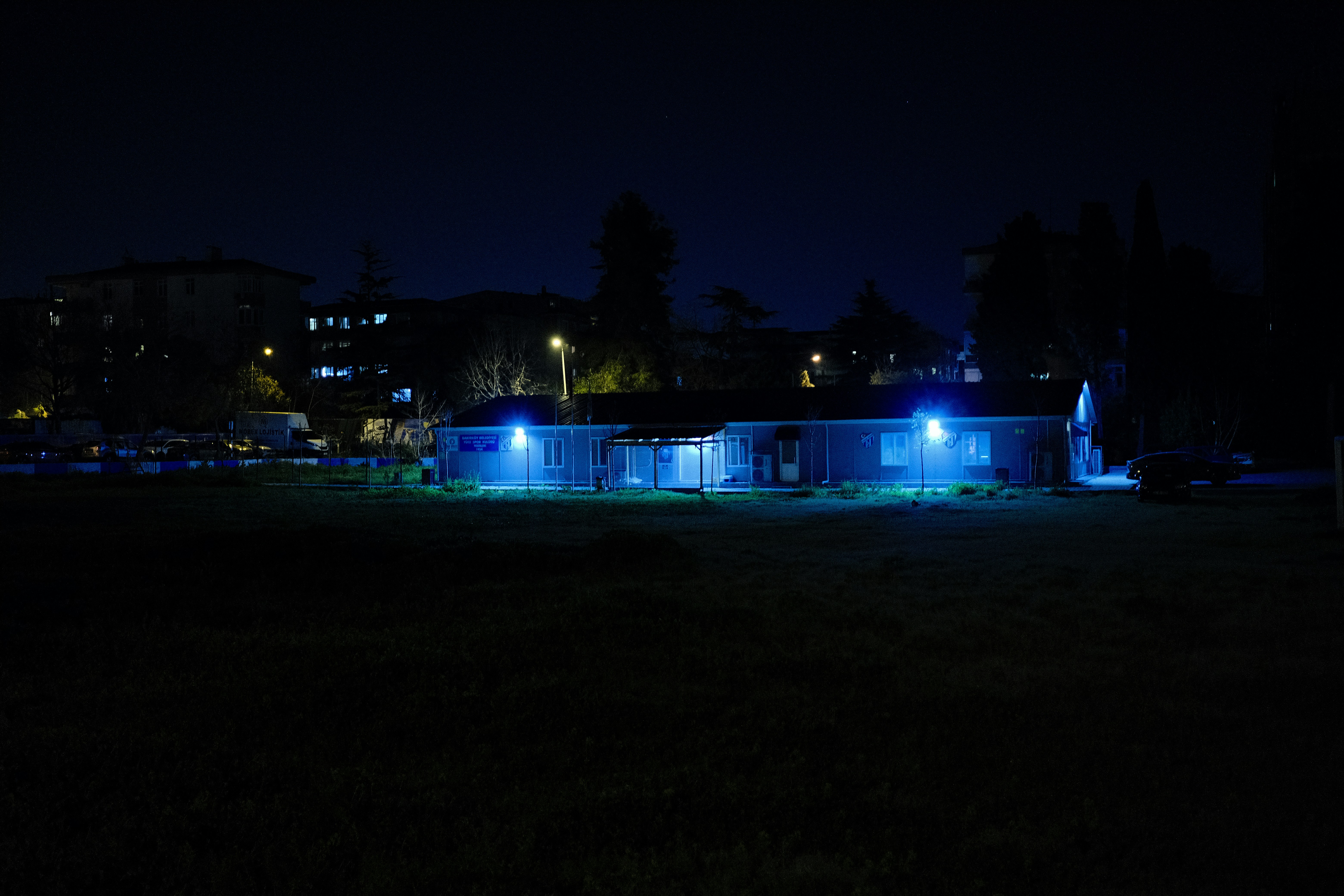 Blue Night Station: Suburban Confinement Under Neon Sky