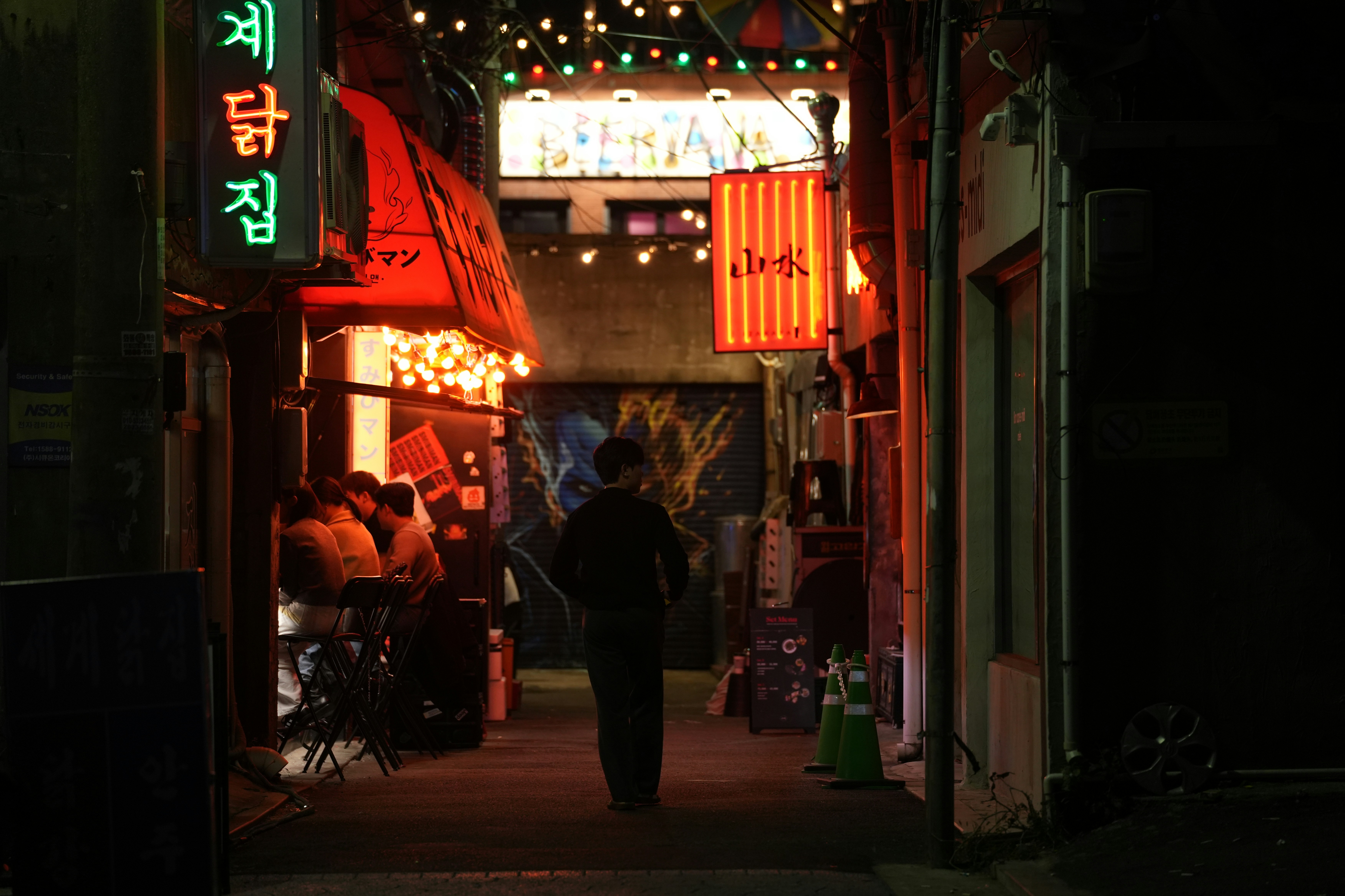 Midnight Alley: Neon glow and silhouettes in a narrow urban alley