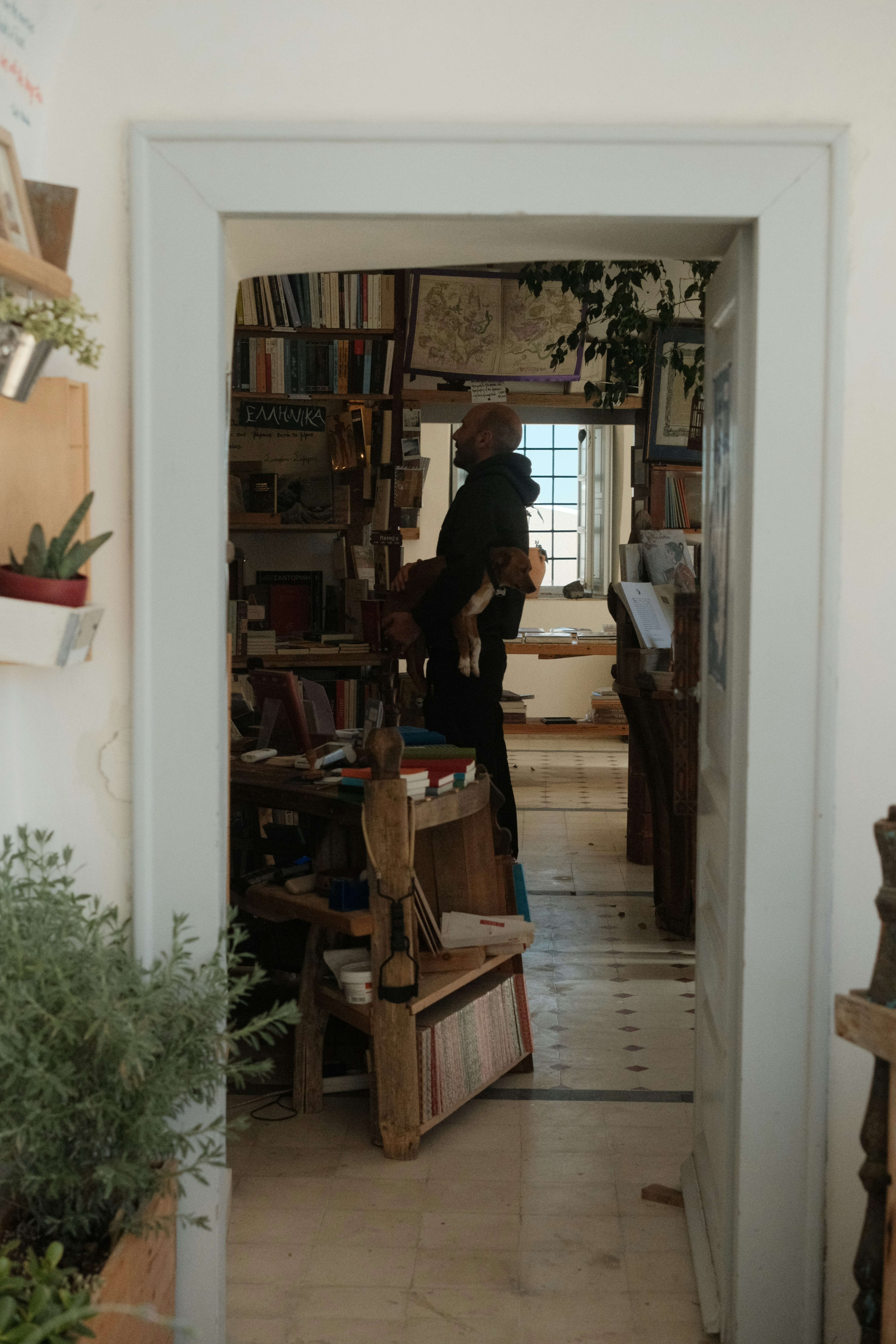 Doorway to a Quiet Library: A Man Holding a Child Amid Stacks