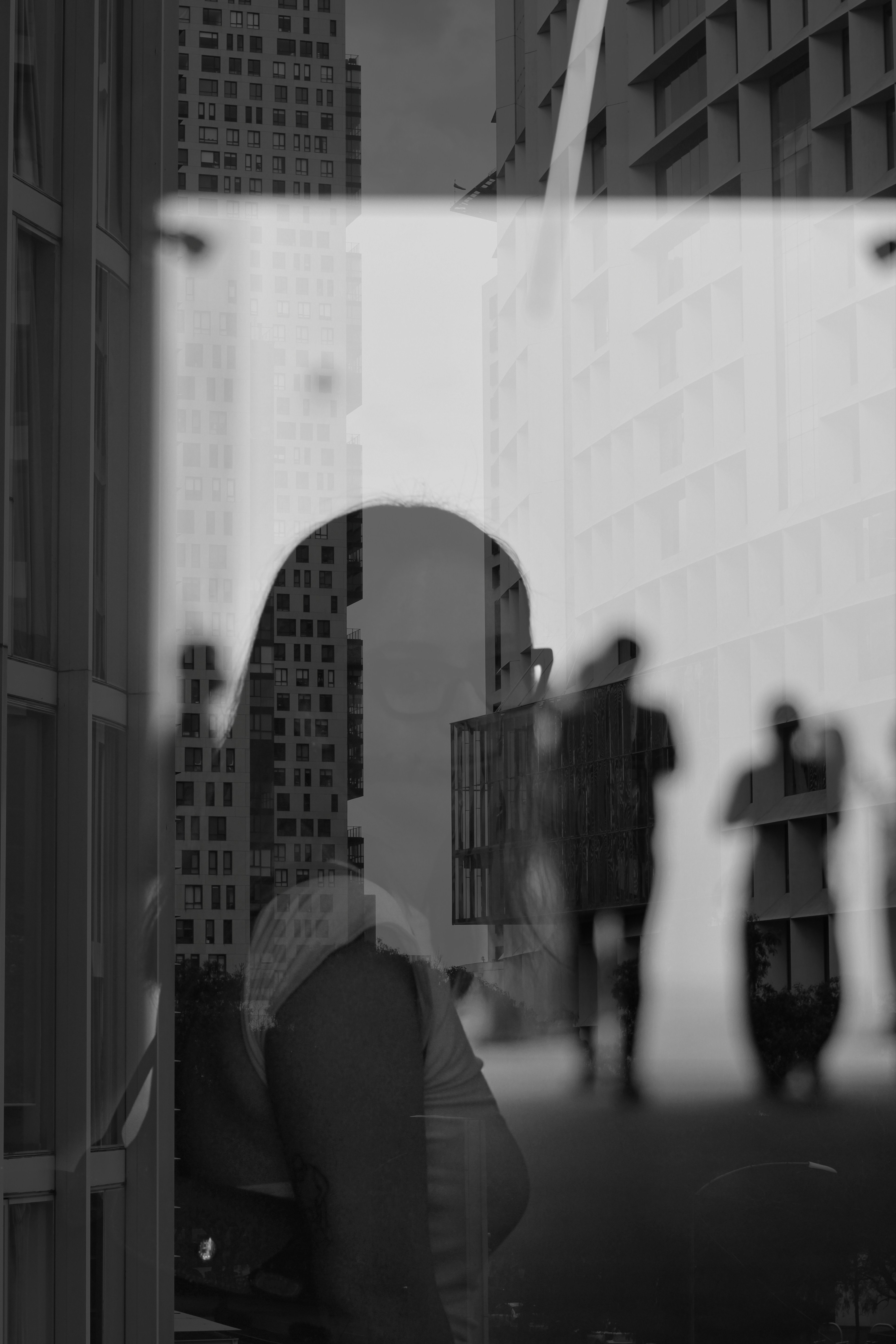 Urban Ghosts: A Silhouette Through Double Glass