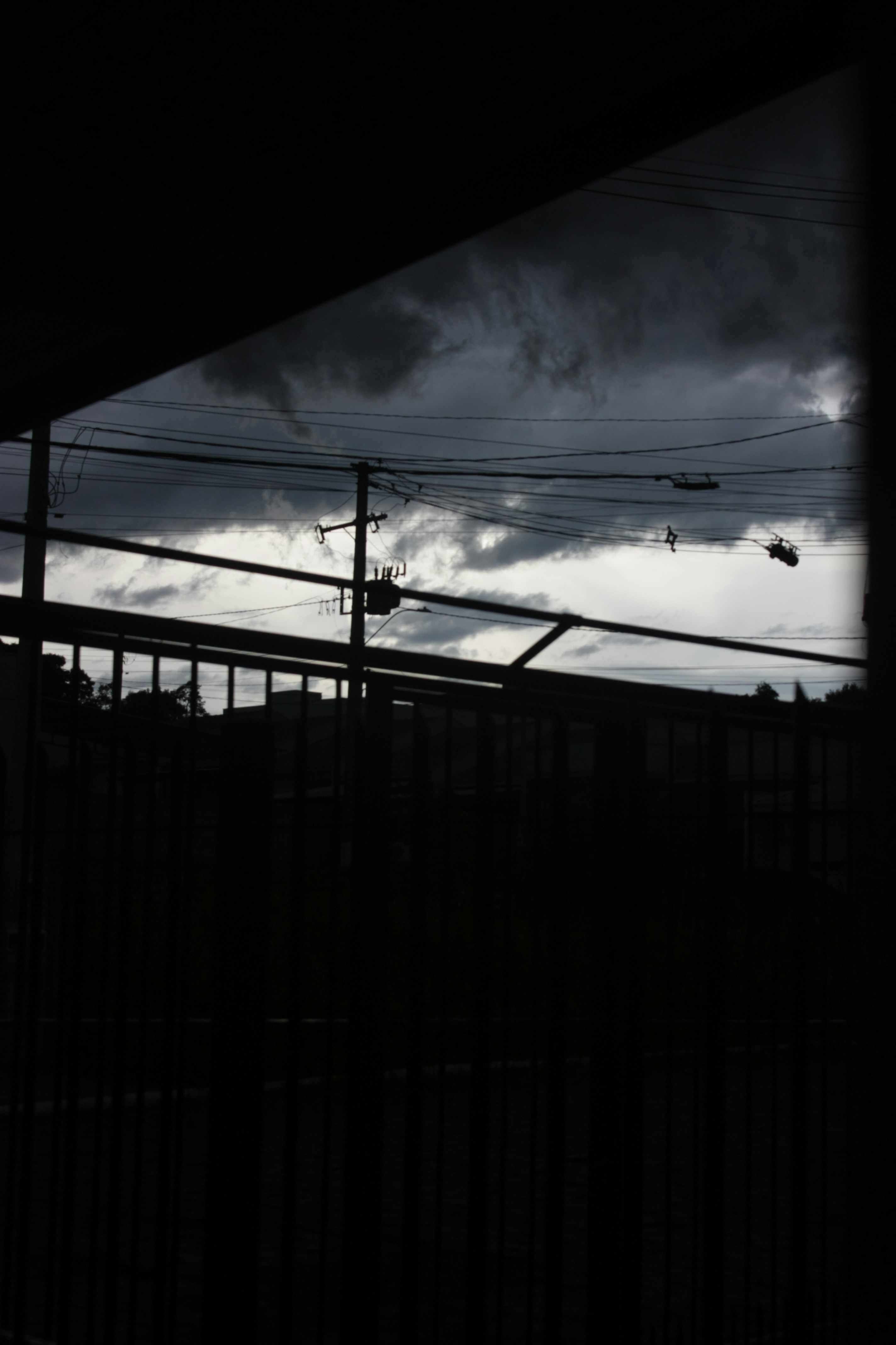  dusk over a silhouetted fence and power lines