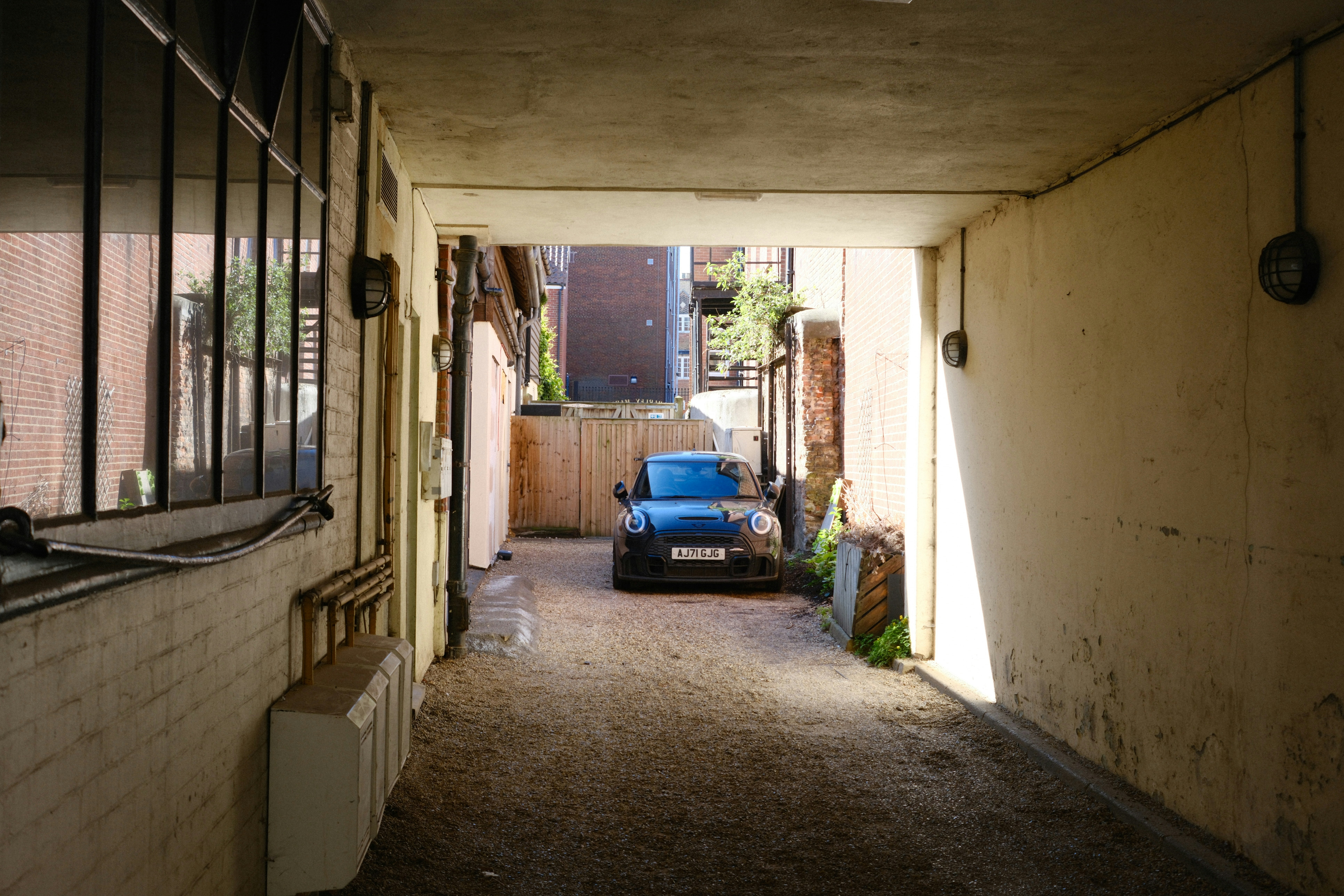 Blue Car in an Urban Passageway
