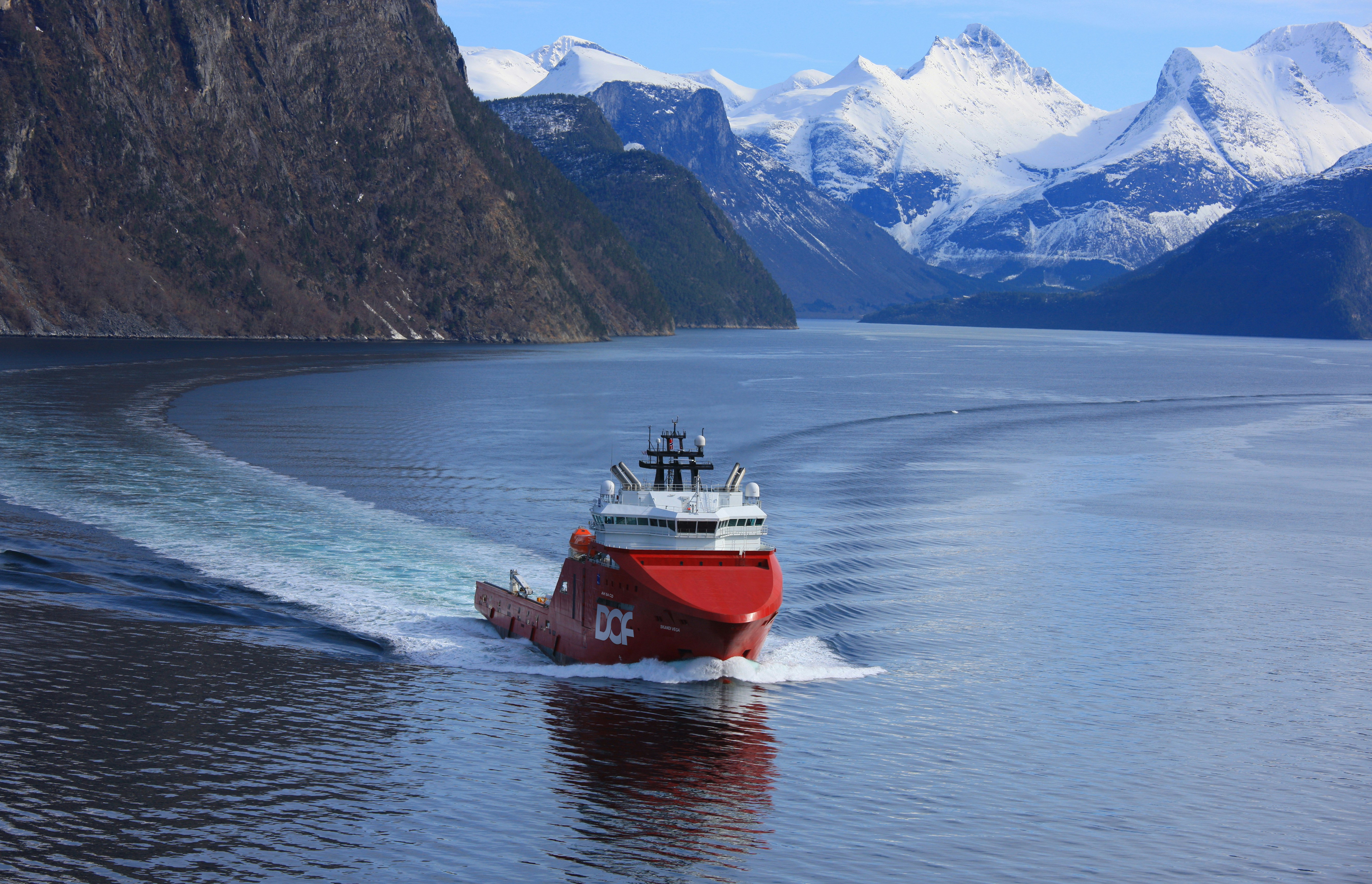 Red Rescue Vessel Carves a Red Carpet Across Glacier Fjord