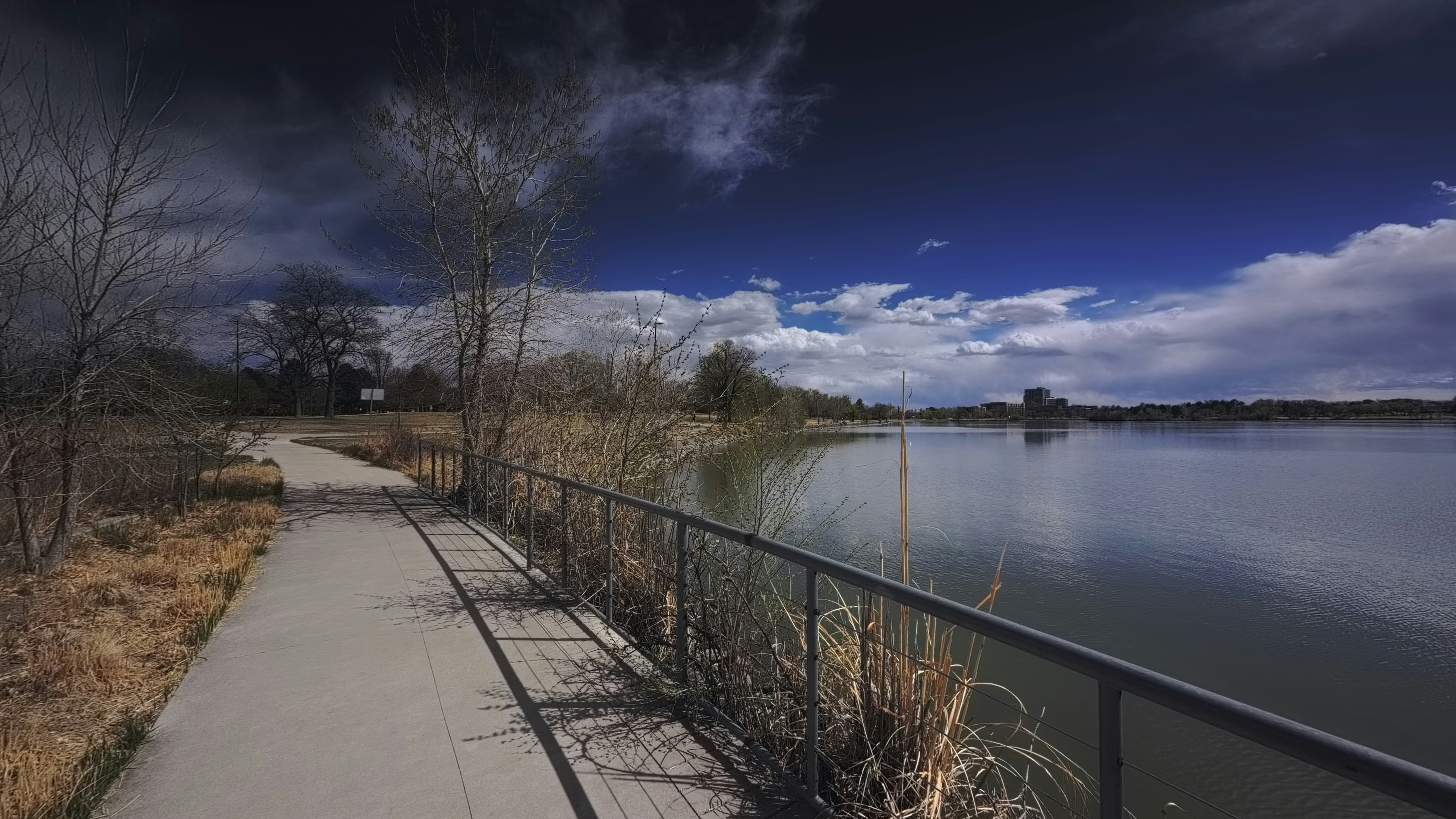 Riverwalk Convergence: A Quiet Path by Glassy Water