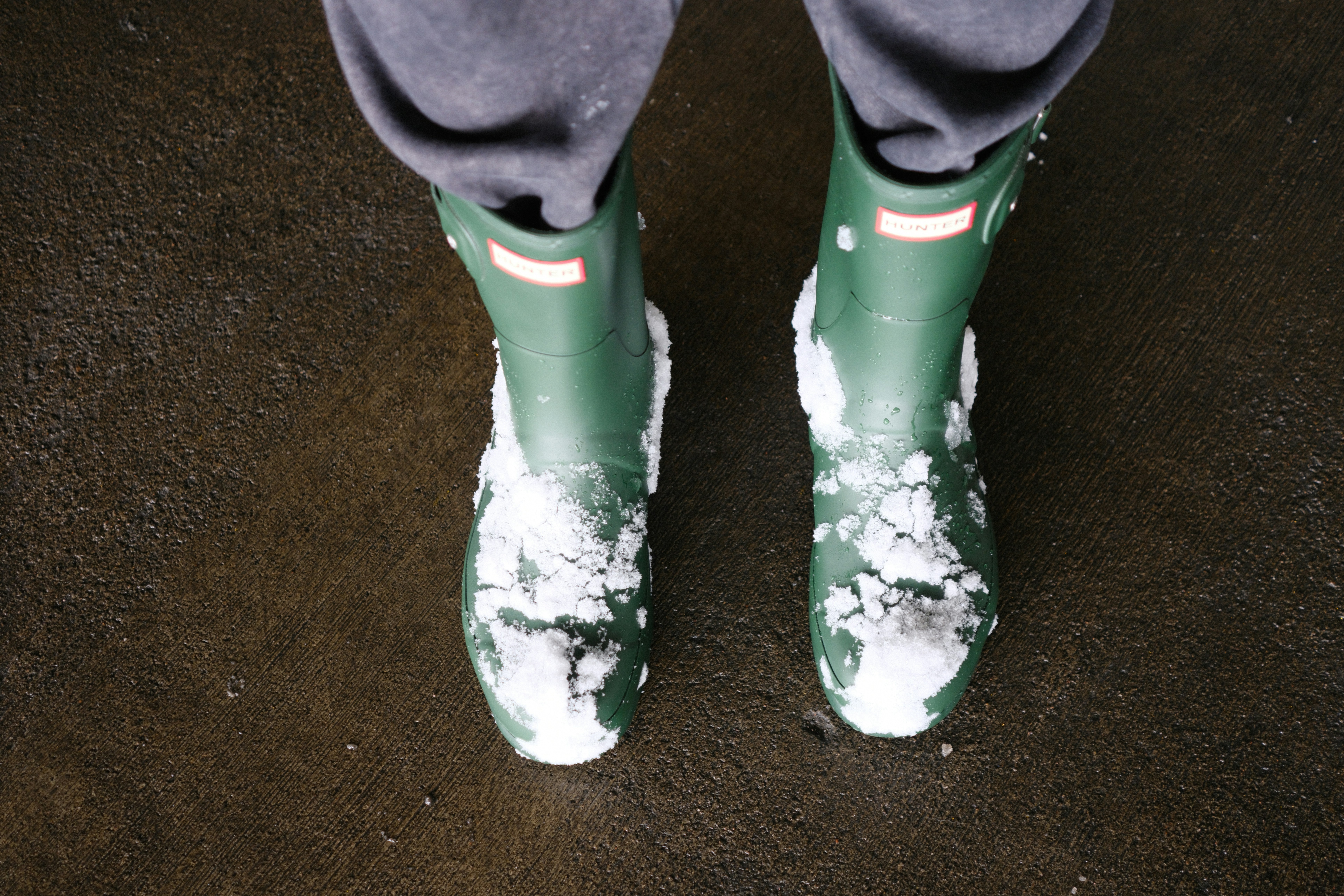 Snowy-green Boots Stand Ready at the Edge of the Ground