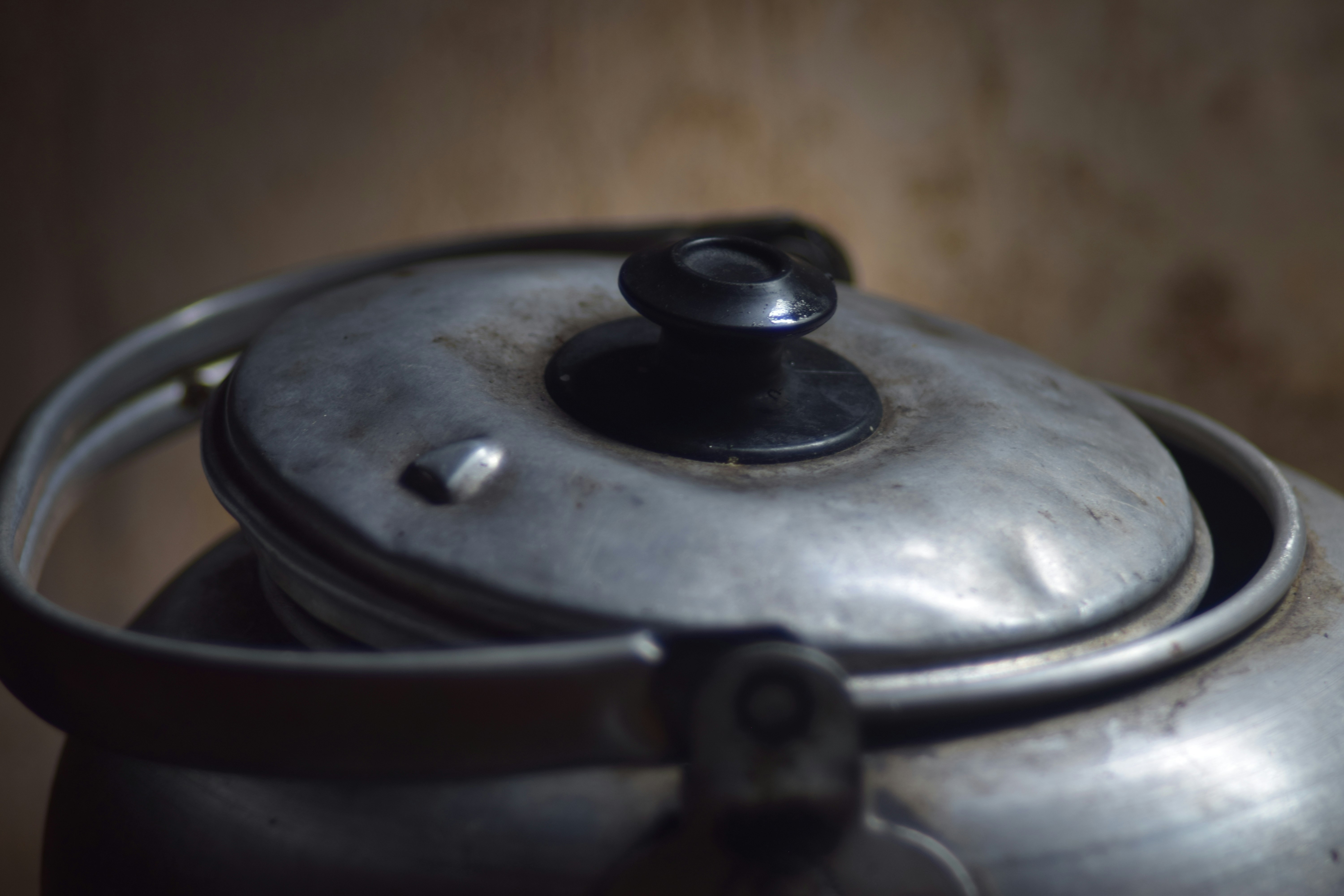 A Weathered Kettle Under Dim Kitchen Light