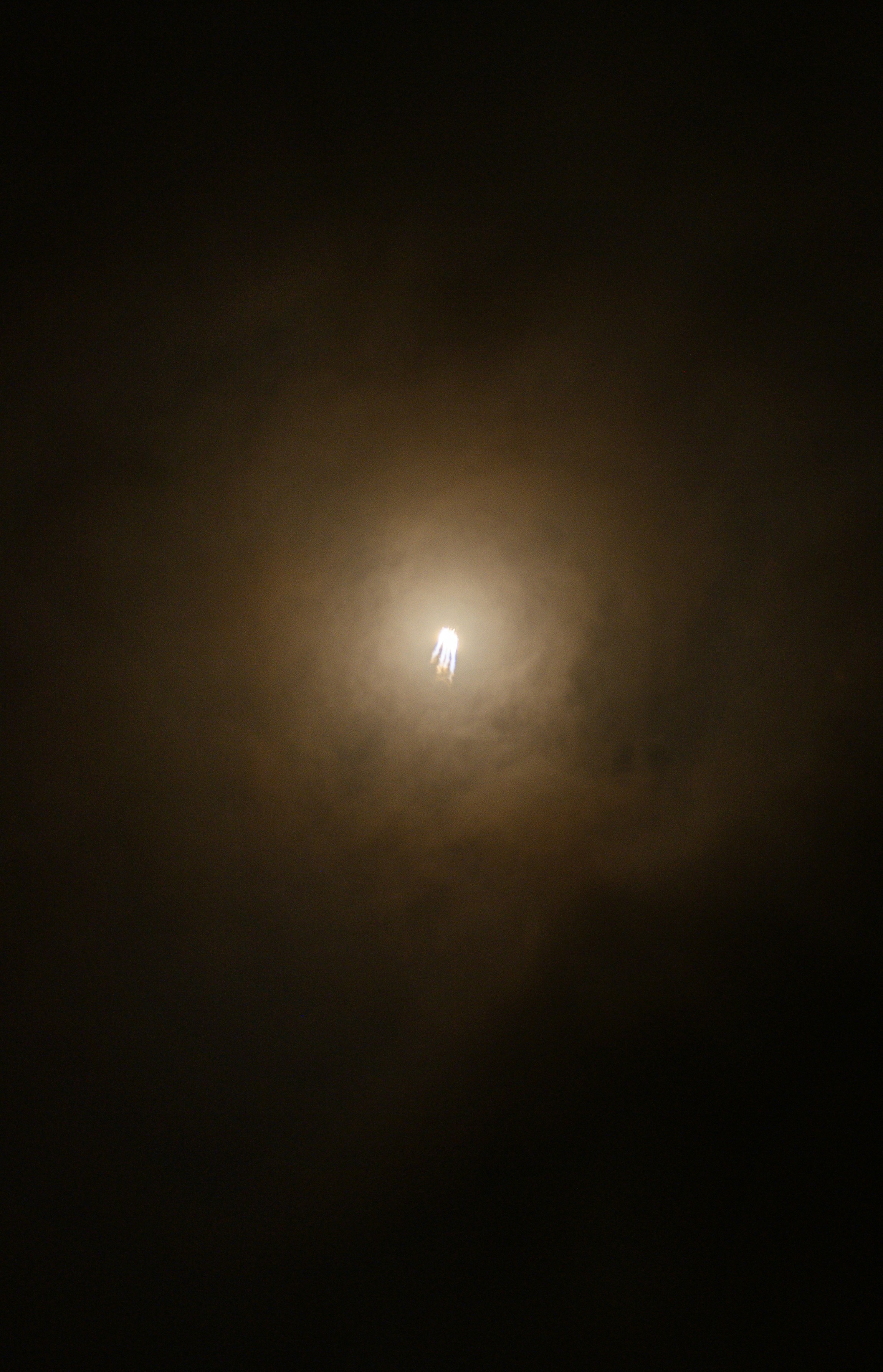 Luminous Ascendancy: A Rocket Breaks Through Evening Clouds