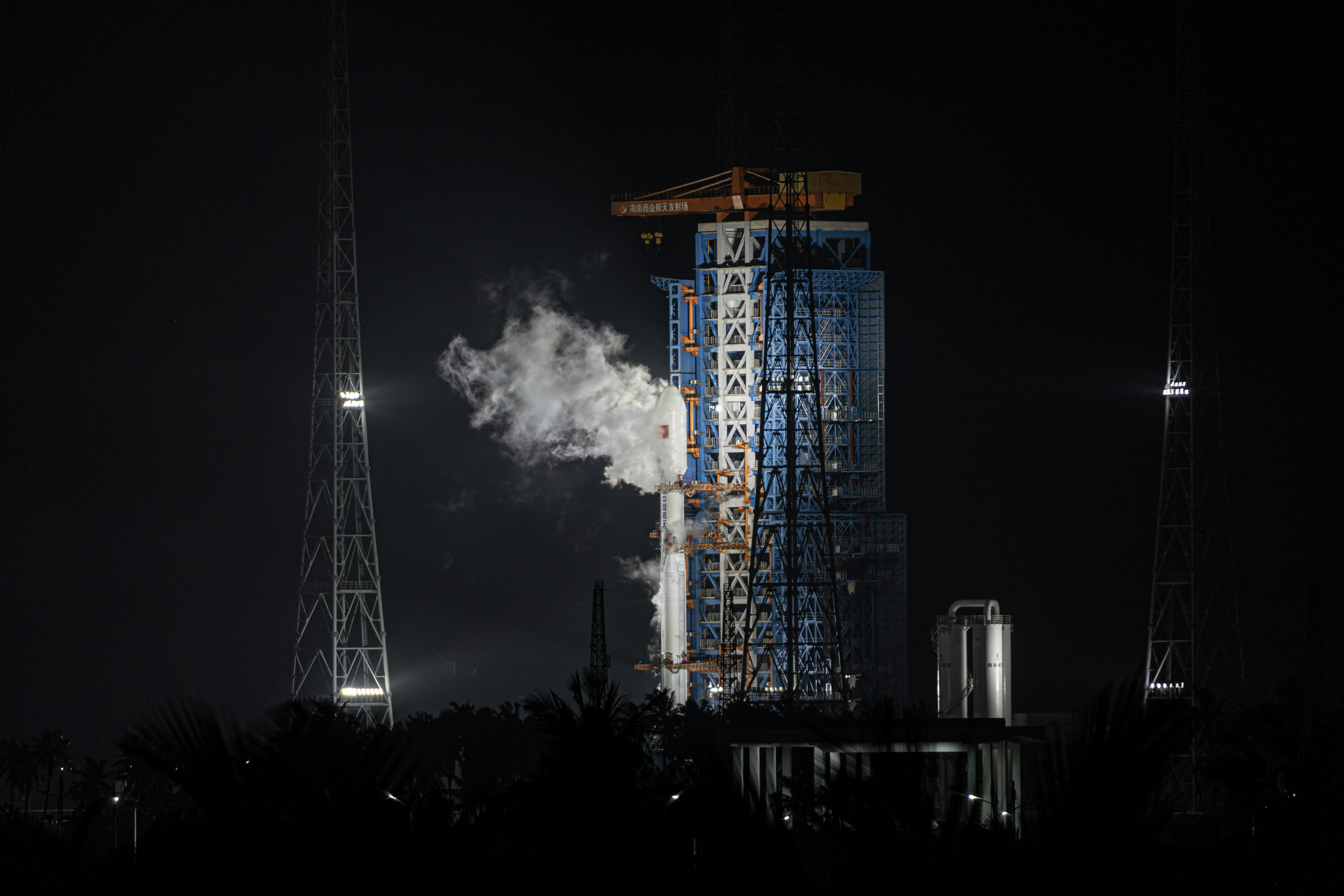 Night Launch Tower: Steam and Structure Against the Dark Sky