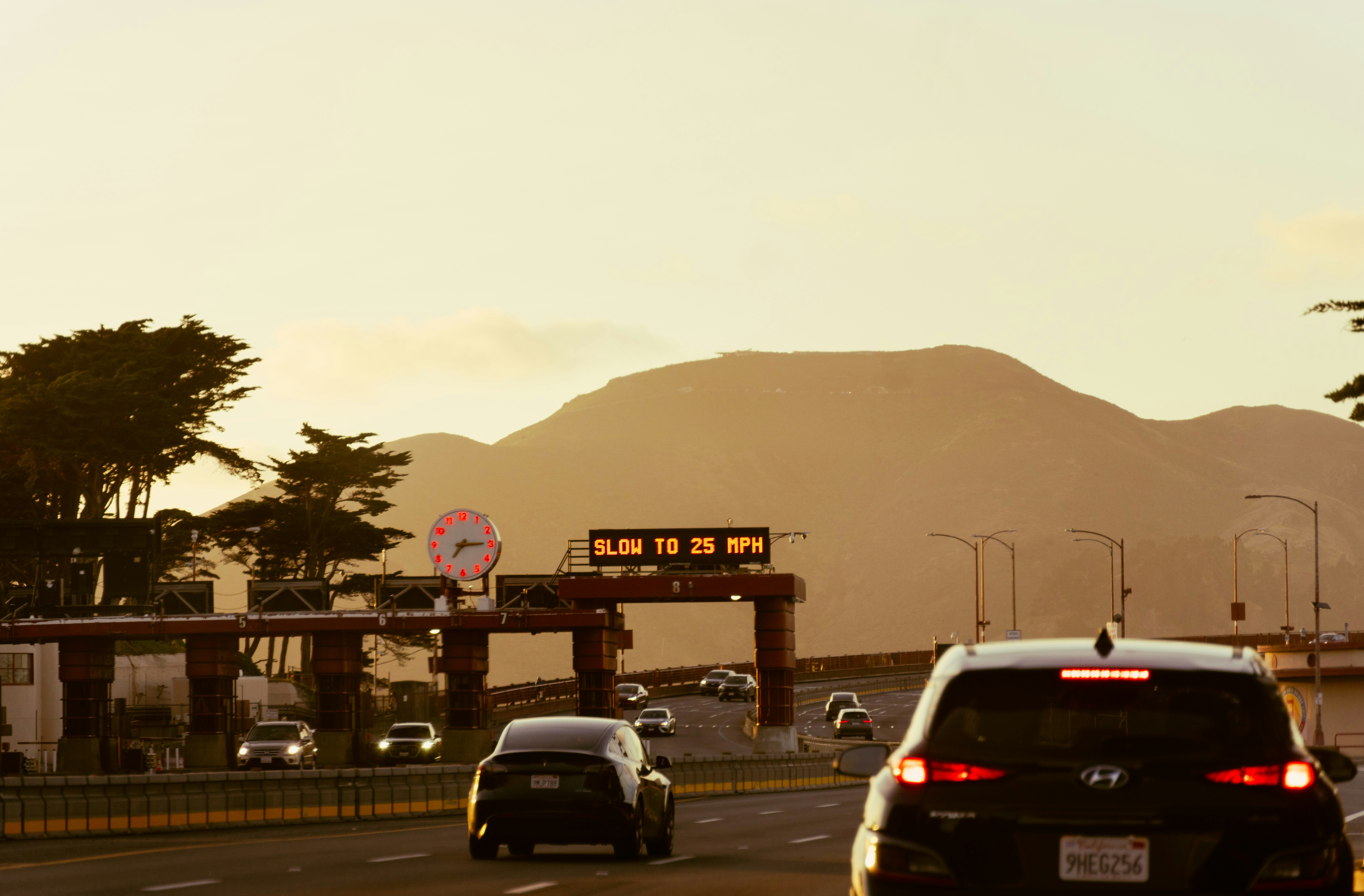 Evening Highway Contrast: Cars under a Sunset Panorama