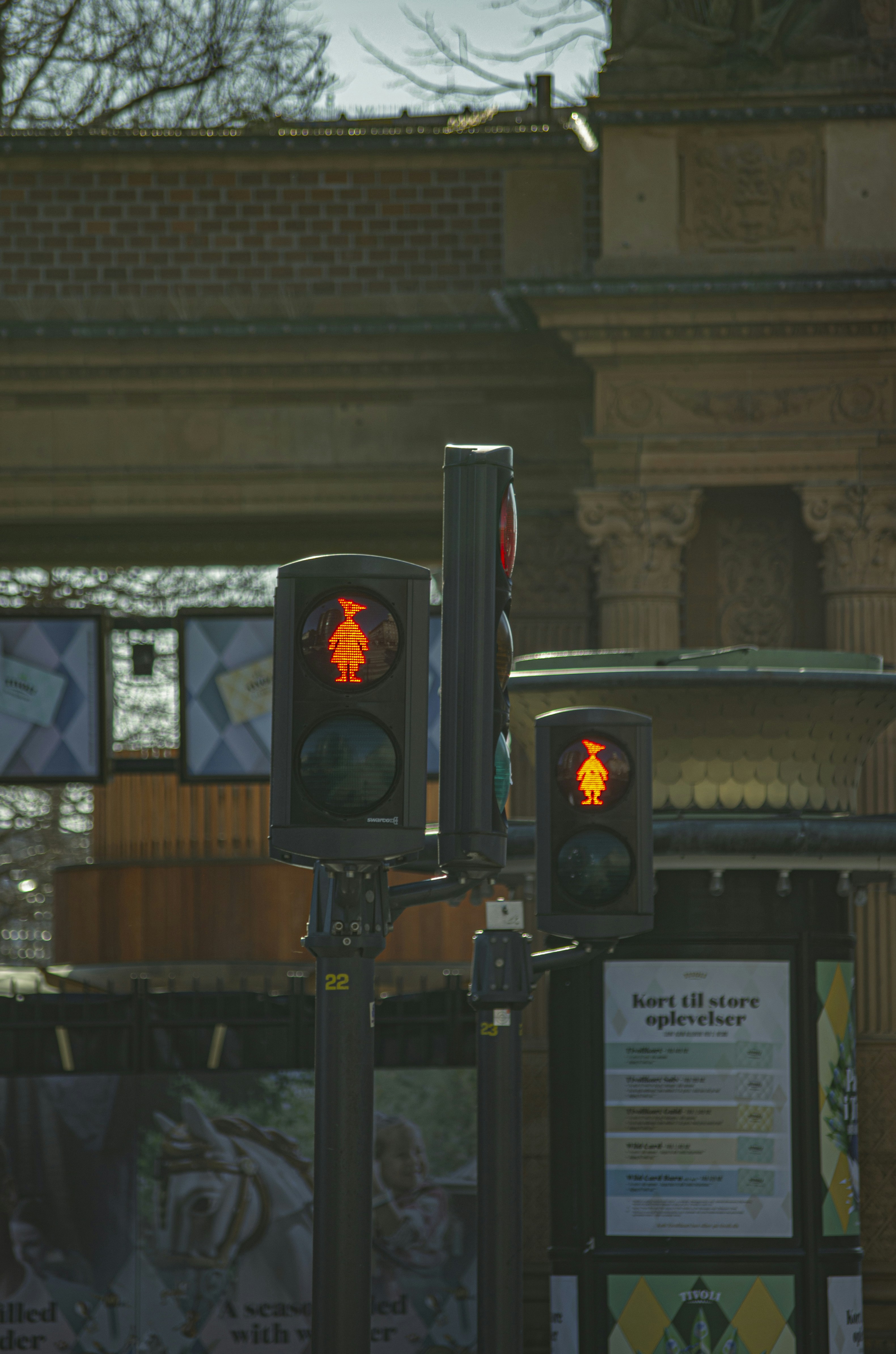 Orange Pedestrian Signal Framed by Historic Architrave