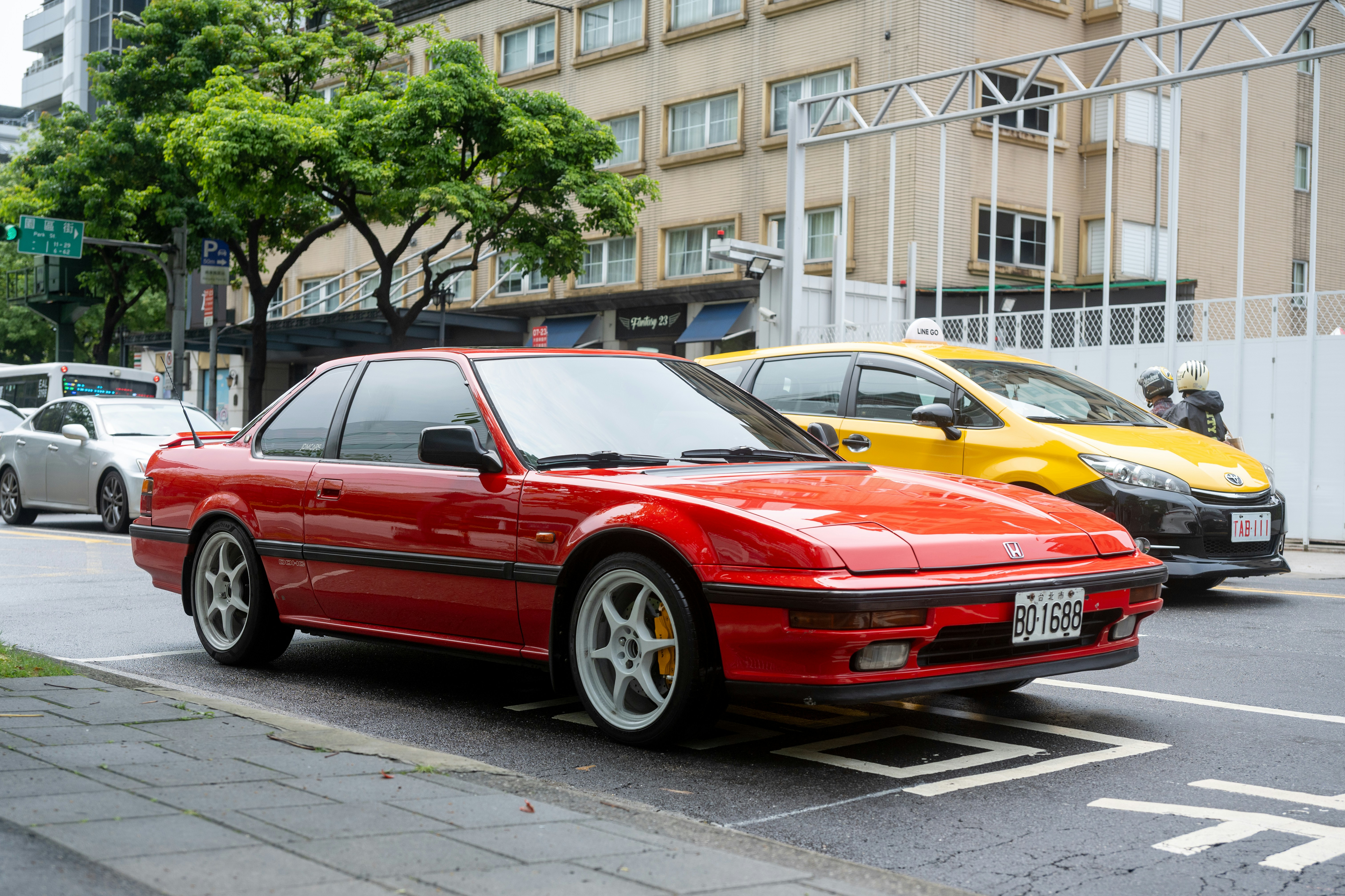 Scarlet Italian Stallion Anchored in an Urban Street Scene