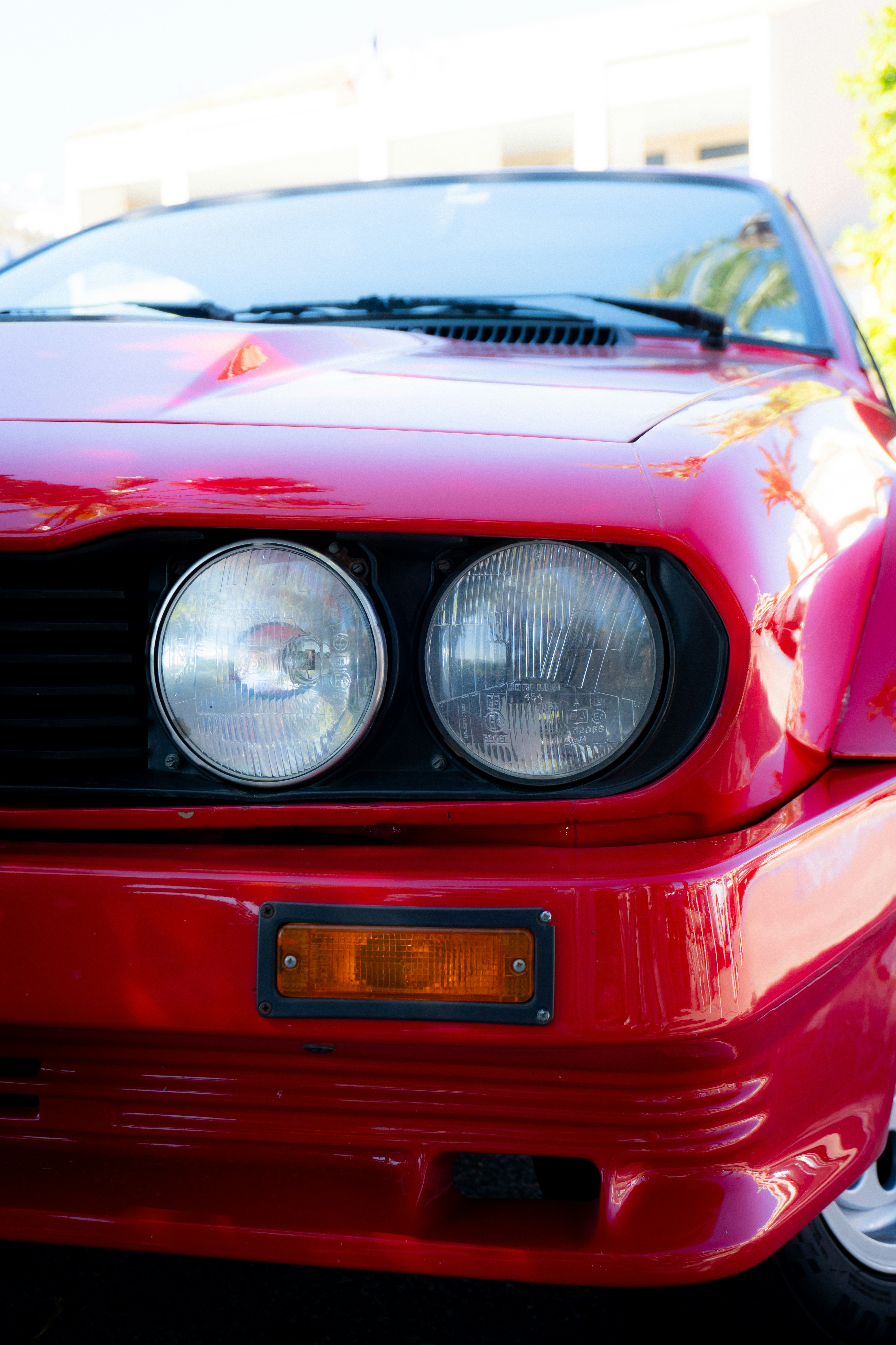Front-intensity: the red classic car's twin headlights