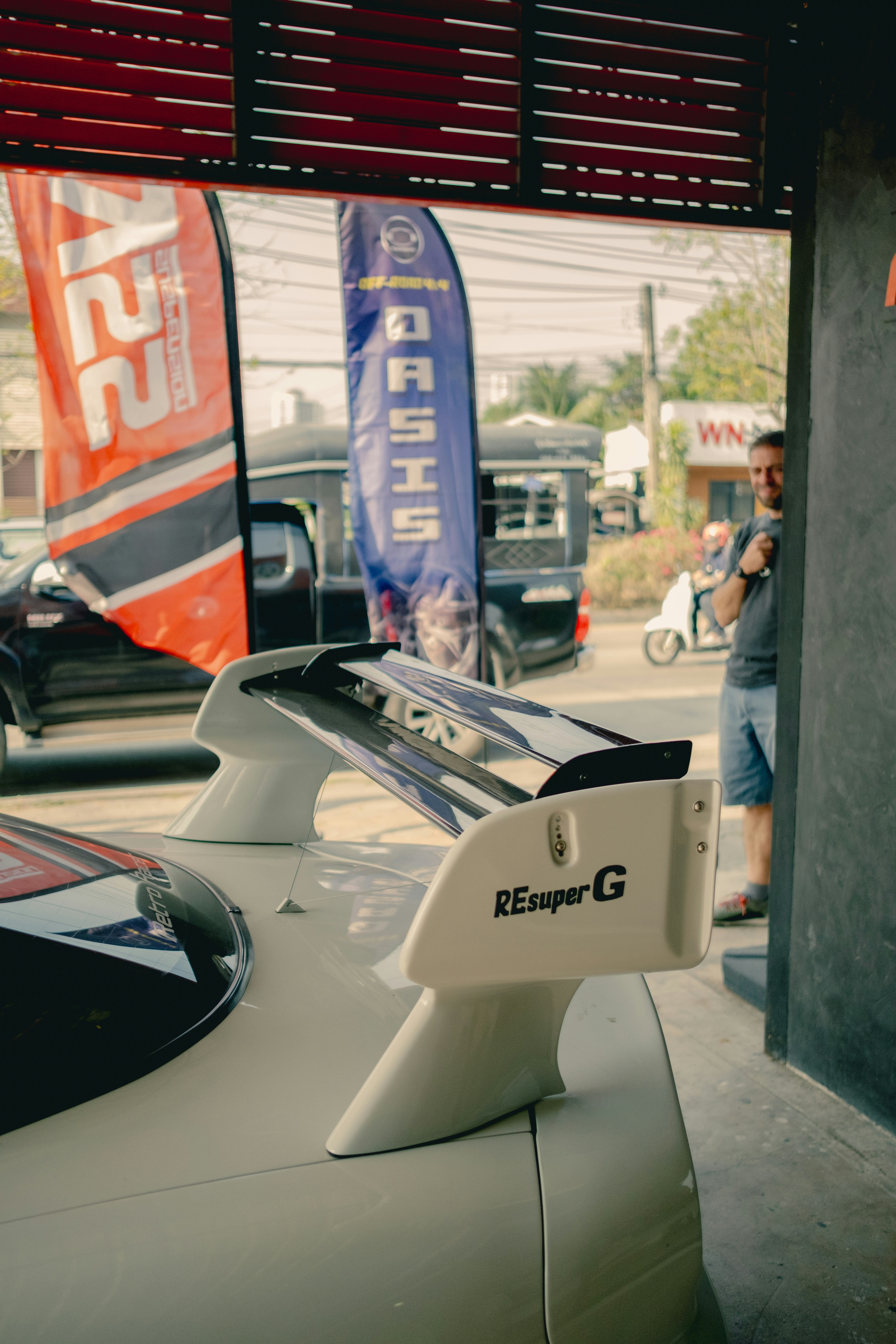 Rear Wing Glory: A Close-Up of the White Race Car's Aerodynamic Spoiler