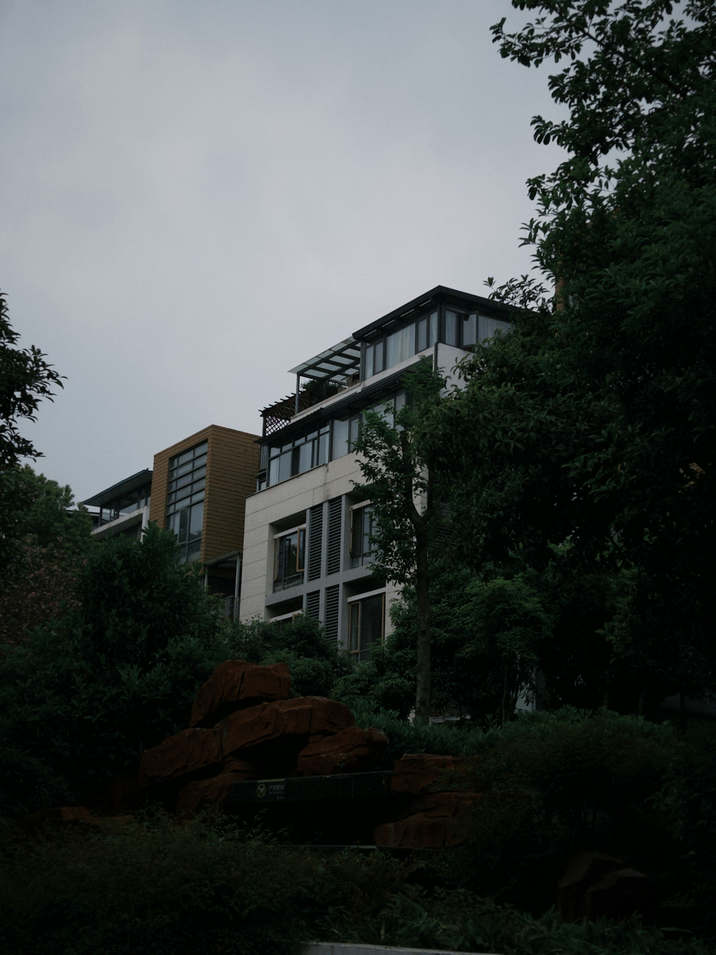 Modern Residency Rises Behind Verdant Canopy