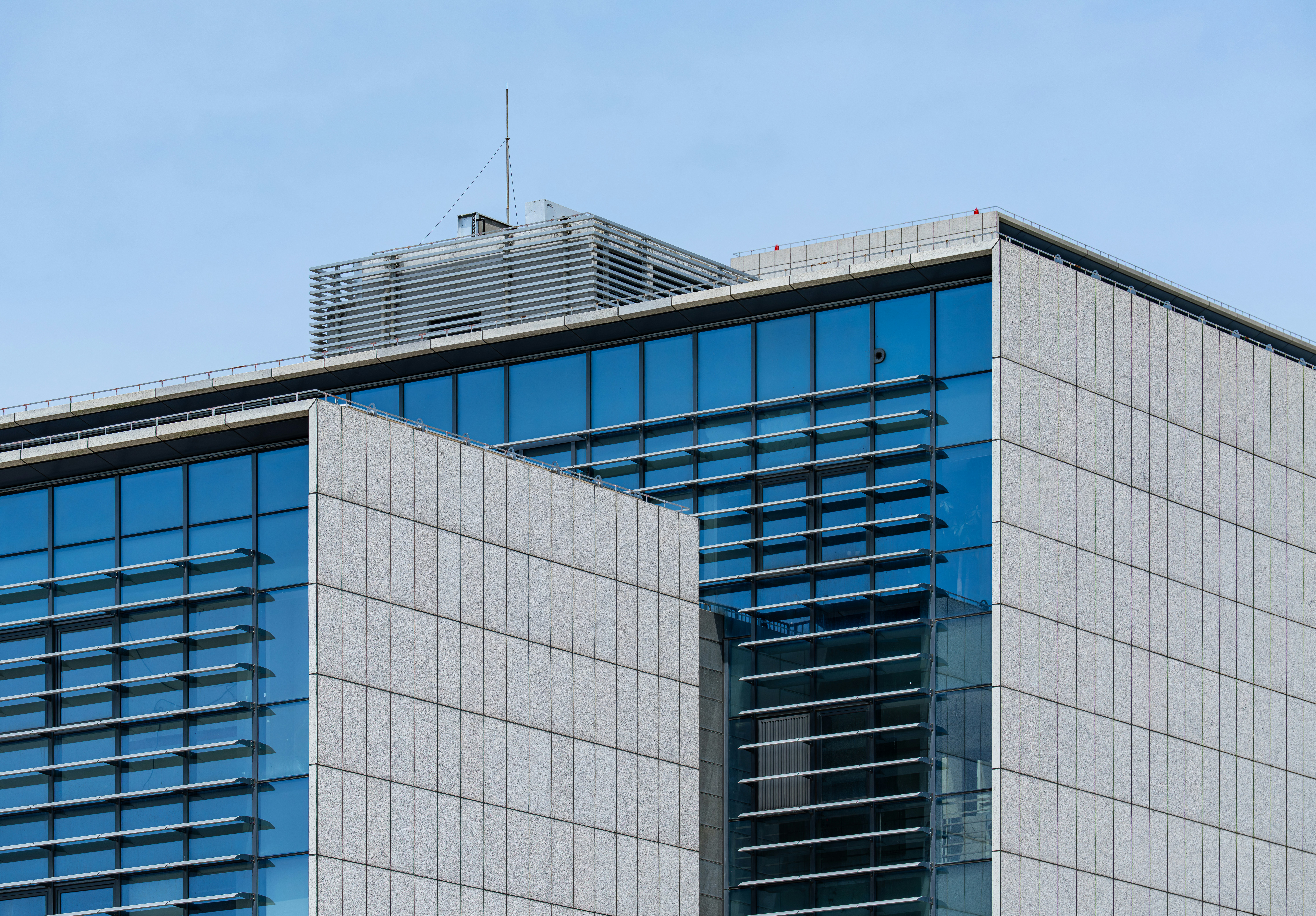 Corner of Glass and Steel: A Modernist Facade Curtained in Blue