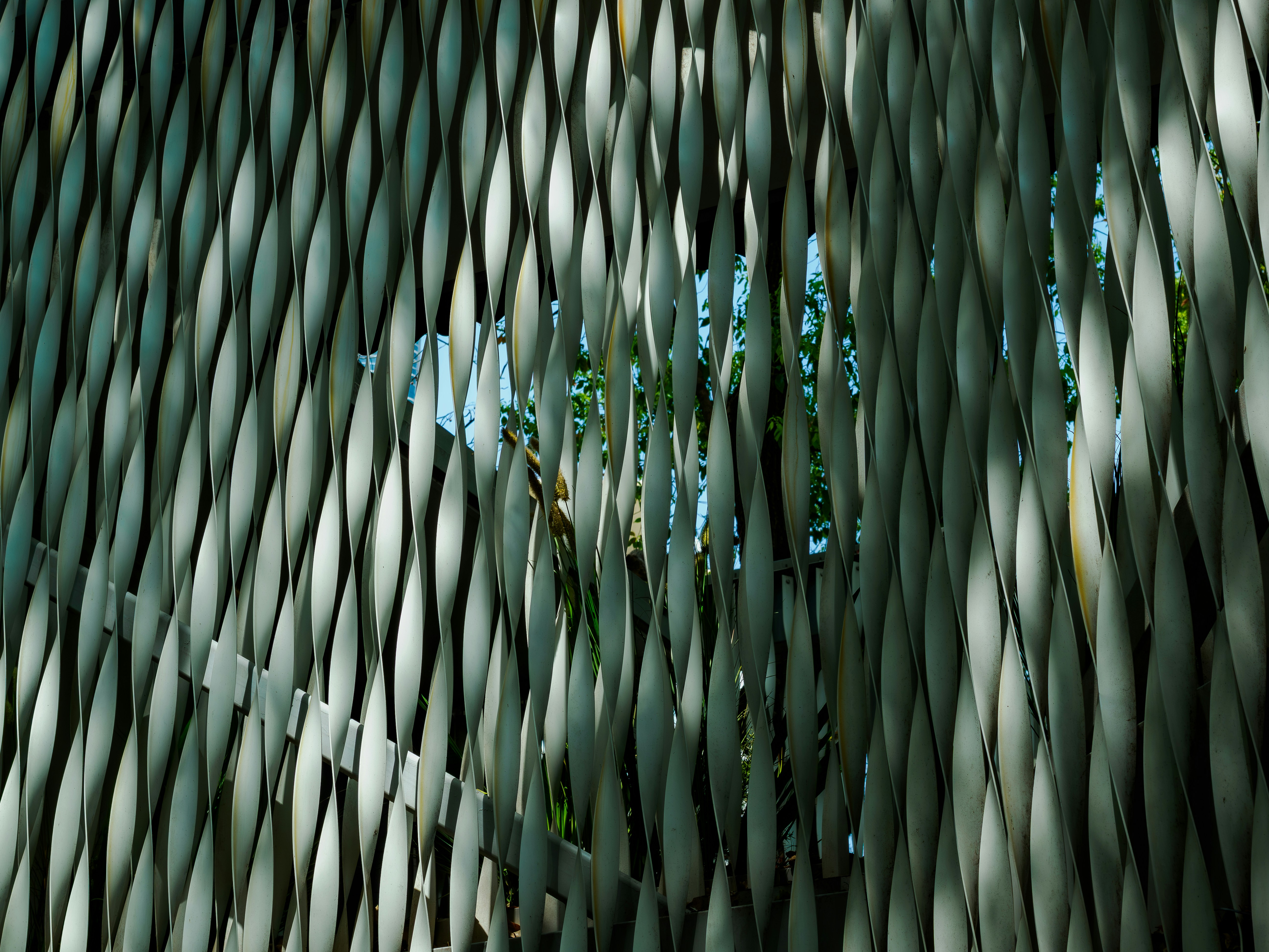 Vertical Veil: A Shaded Corridor of Curved Blades