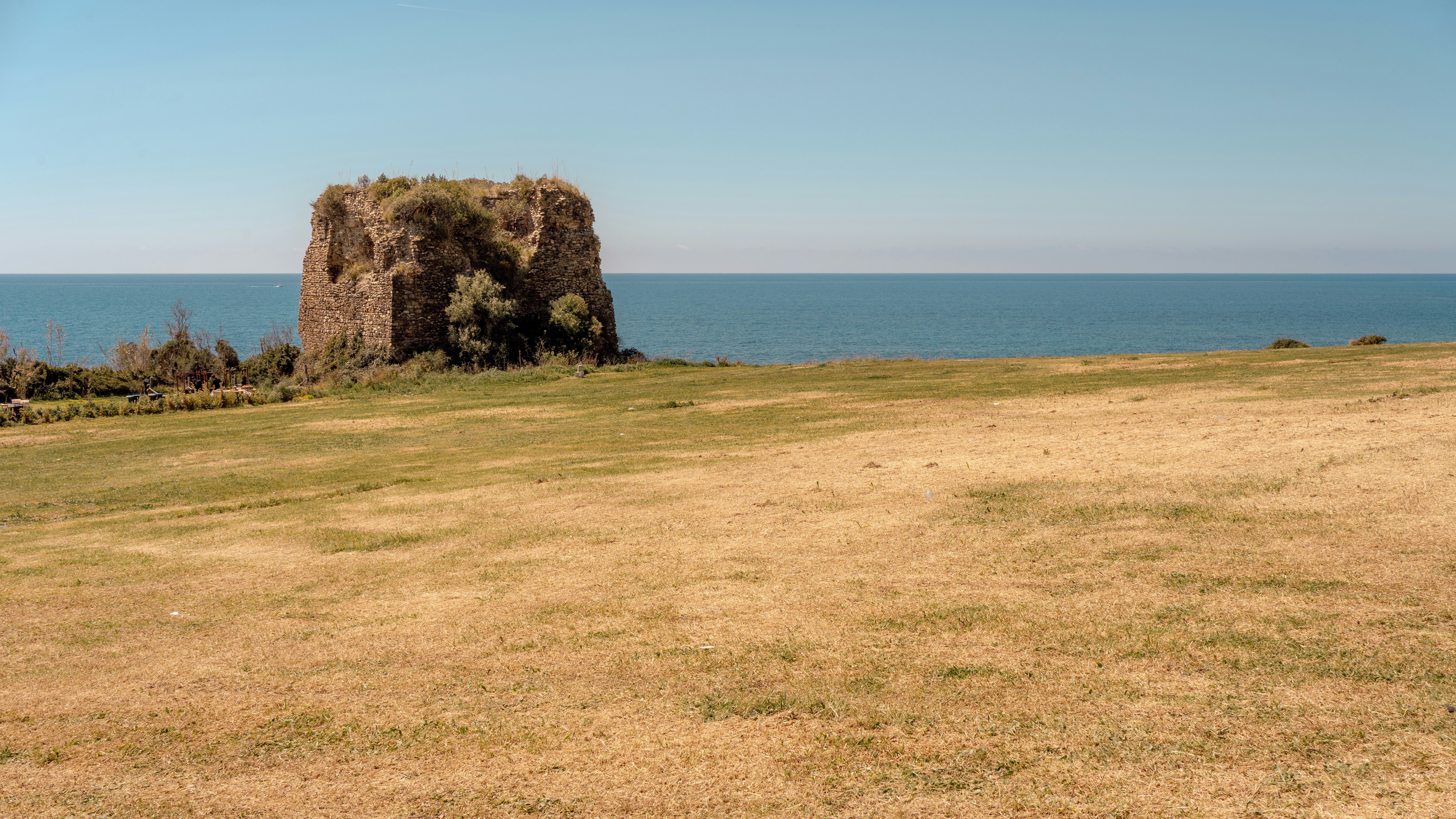 Isolated Sea Sentinel: A Rugged Ruin Beside the Quiet Shore