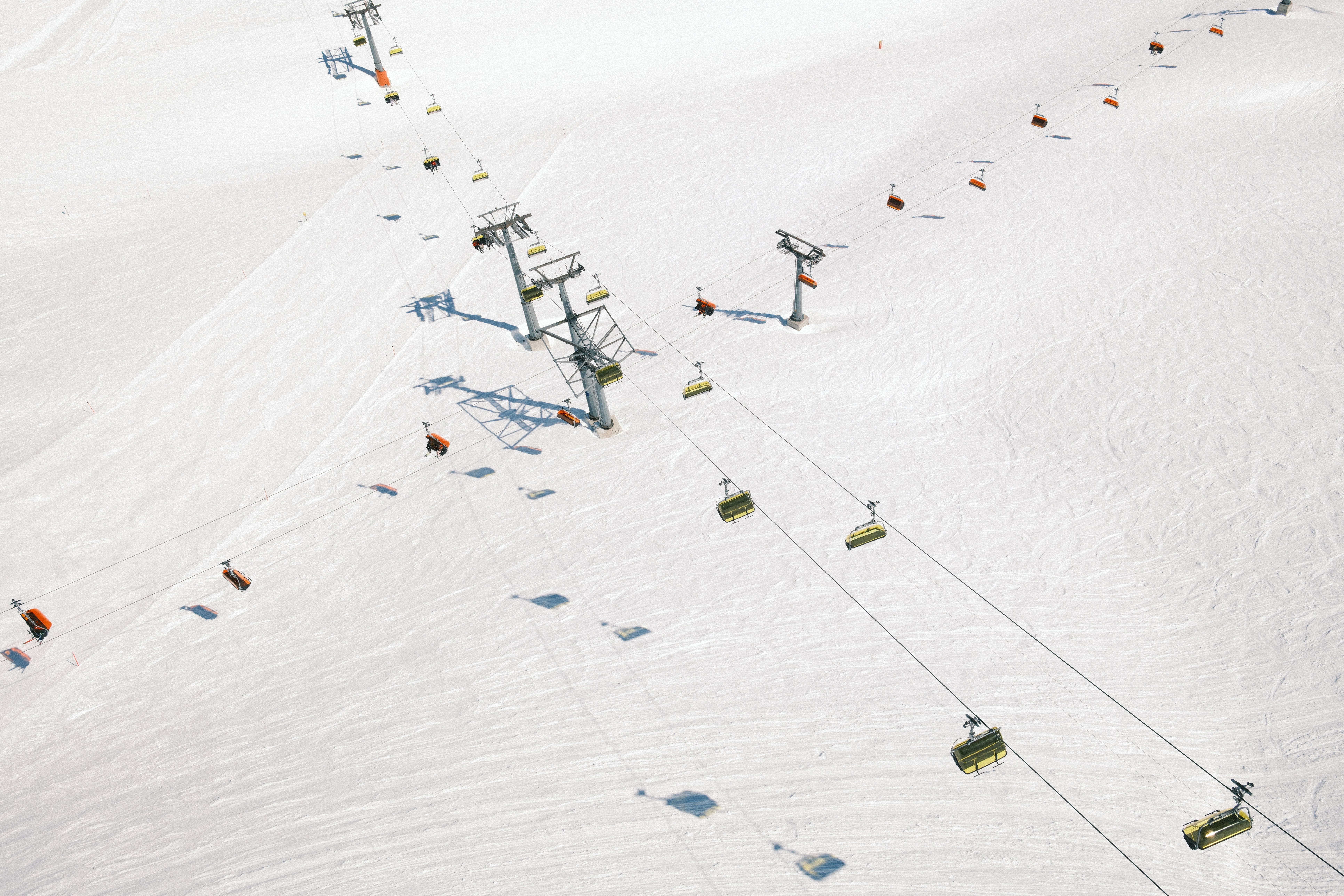Lifts in the White: Aerial Chairs Traversing a Quiet Alpine Field