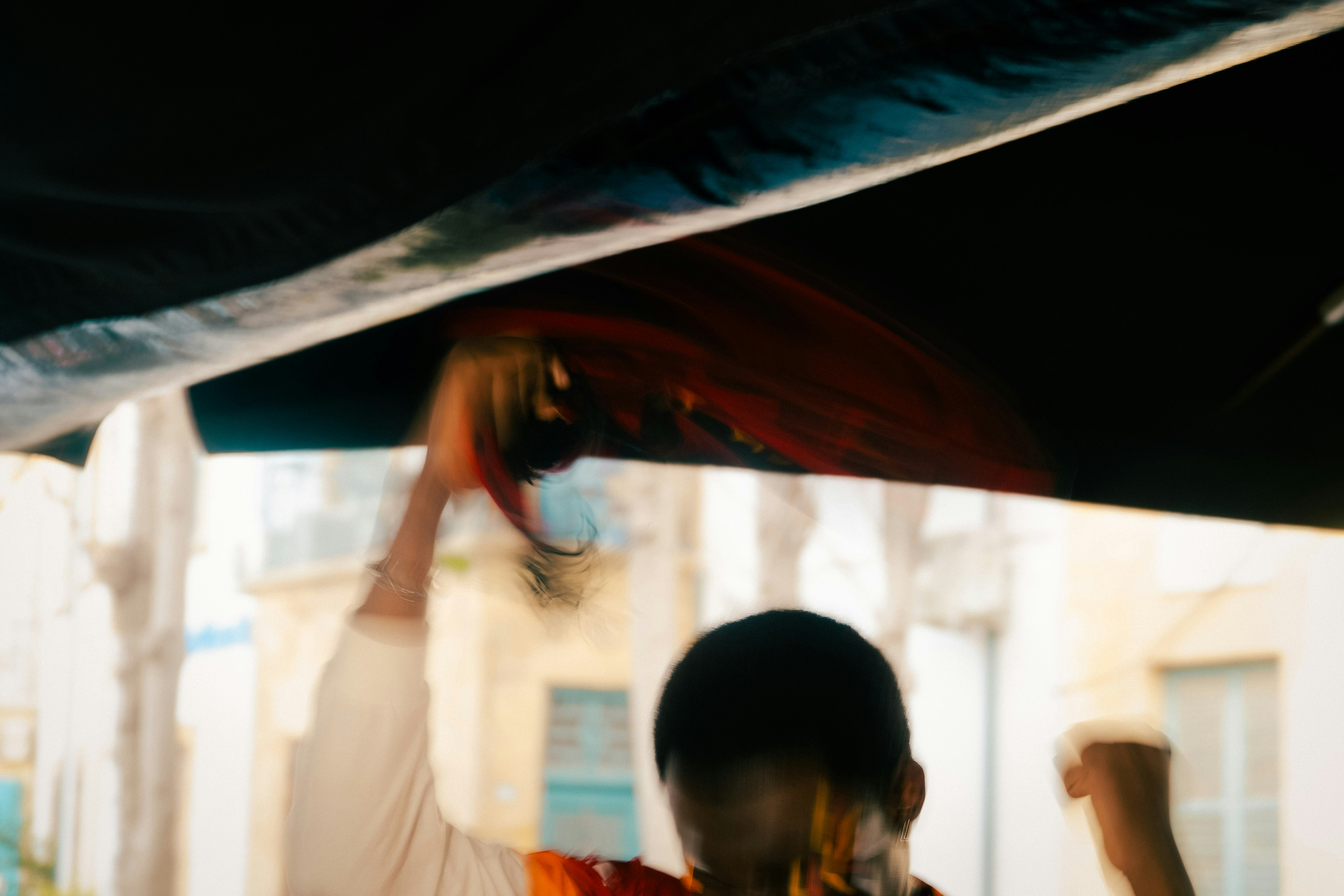 Blurred Motion Under a Tarp: A Rooftop Moment