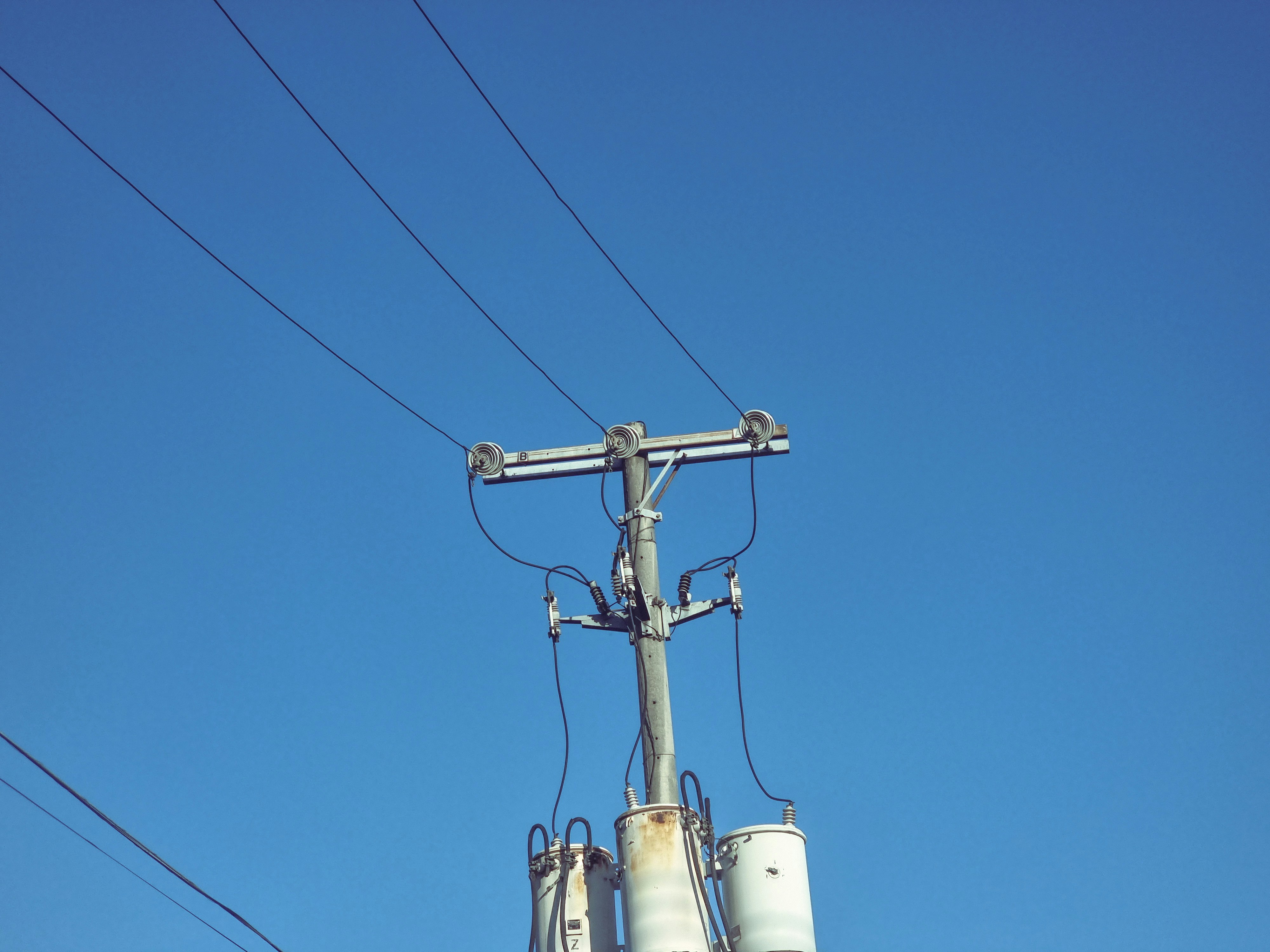 Pole Power: A Quiet Day with a Single Utility Mast Against a Clear Sky