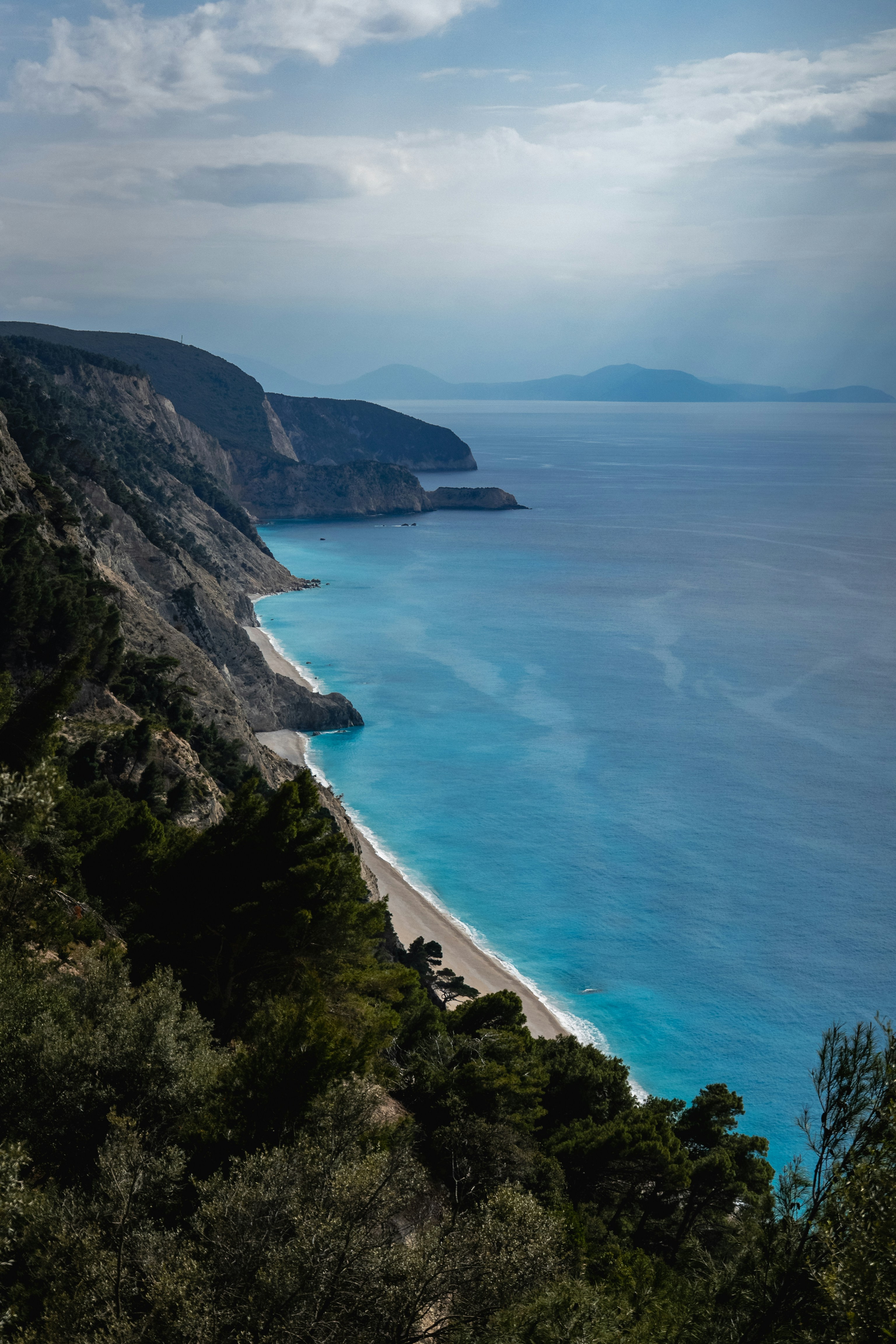 Cliffside Vista: A Serene Aegean-Blue Coast From Above