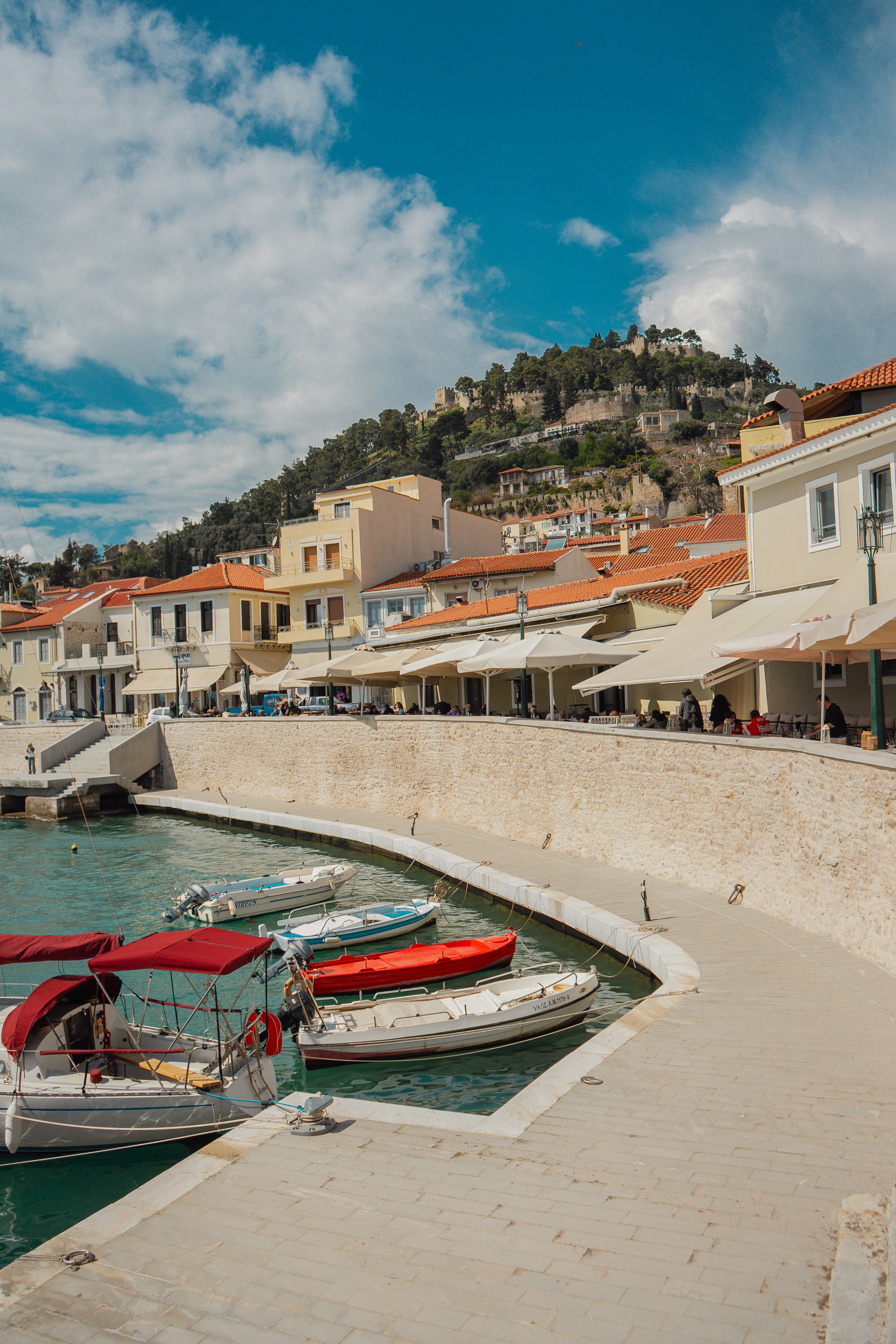 Harbor promenade under a sunlit pastel village