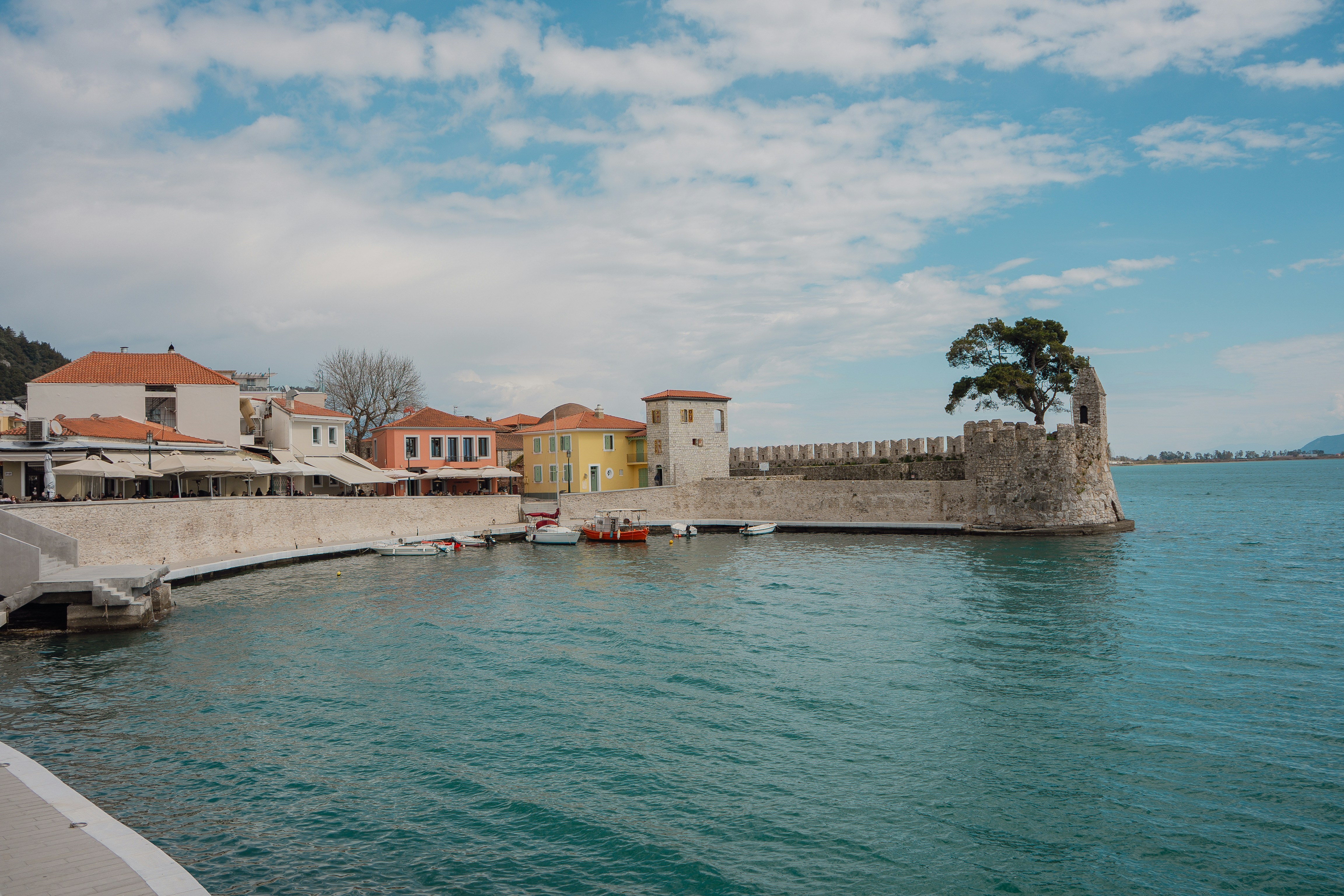 Harbor Front of a Mediterranean Town: Tide, Stone Walls, and Colorful Facades