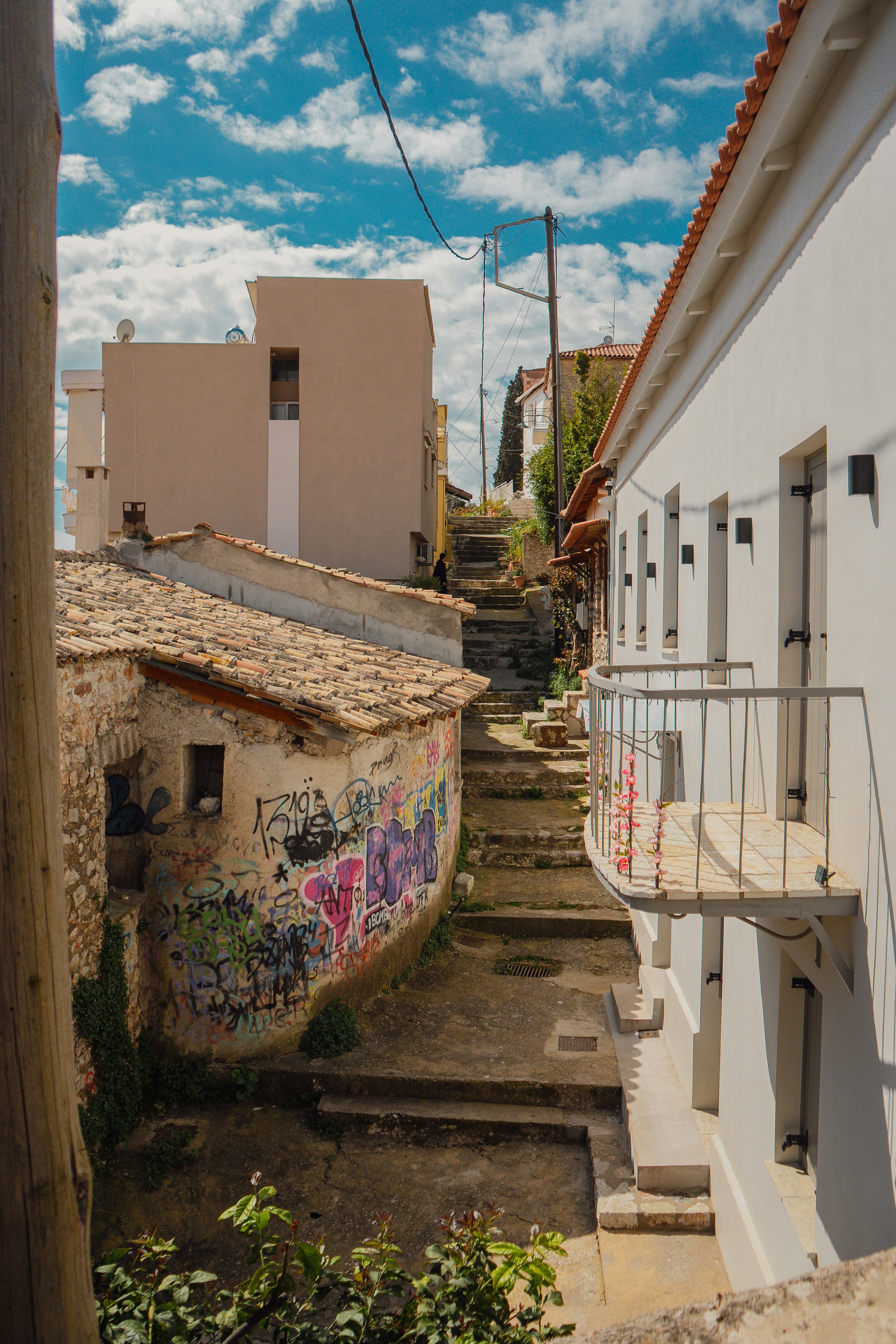 Sunlit Staircase Through a Graffiti-Hued Lane