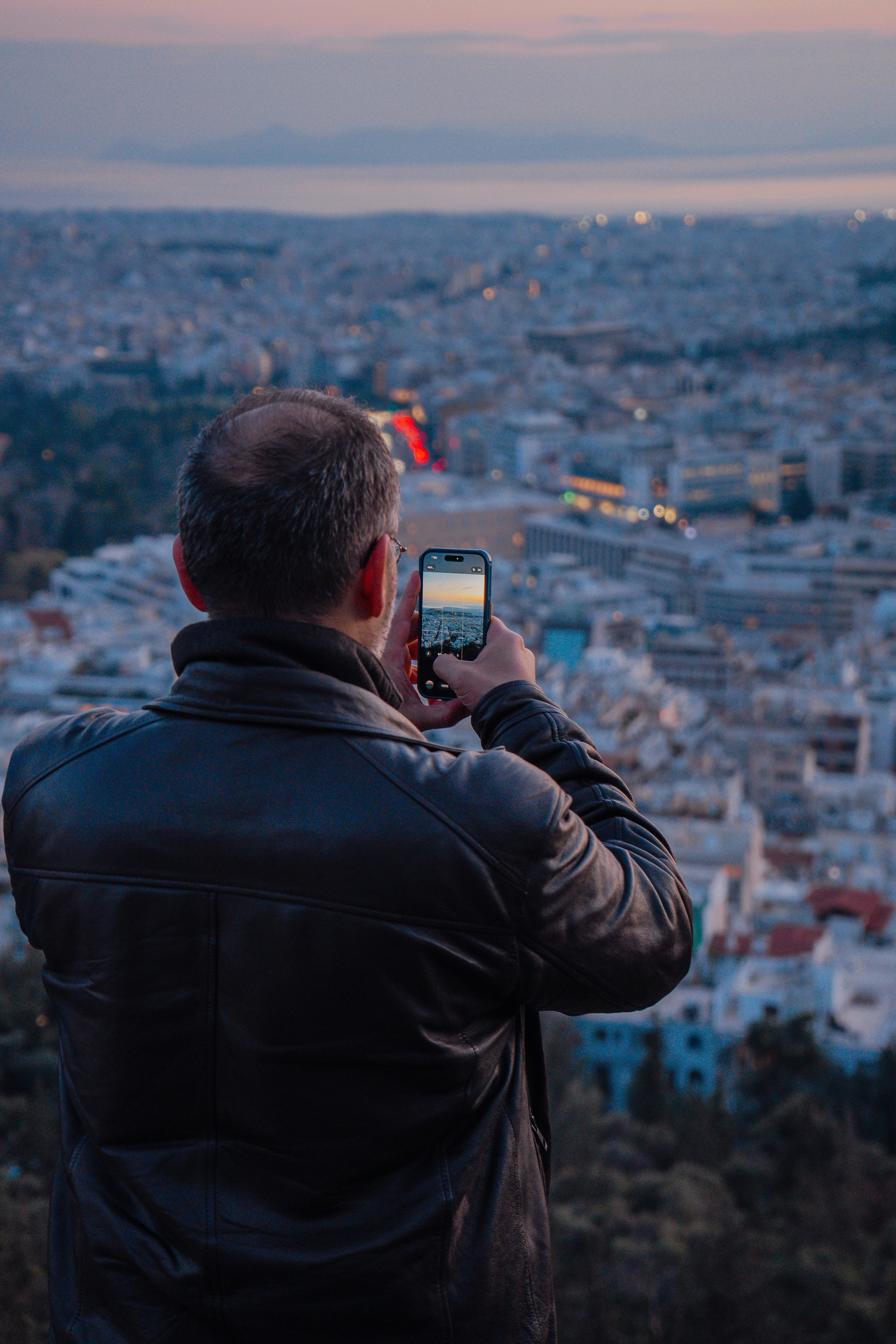 Selfie above the city: capturing the glow of a twilight panorama