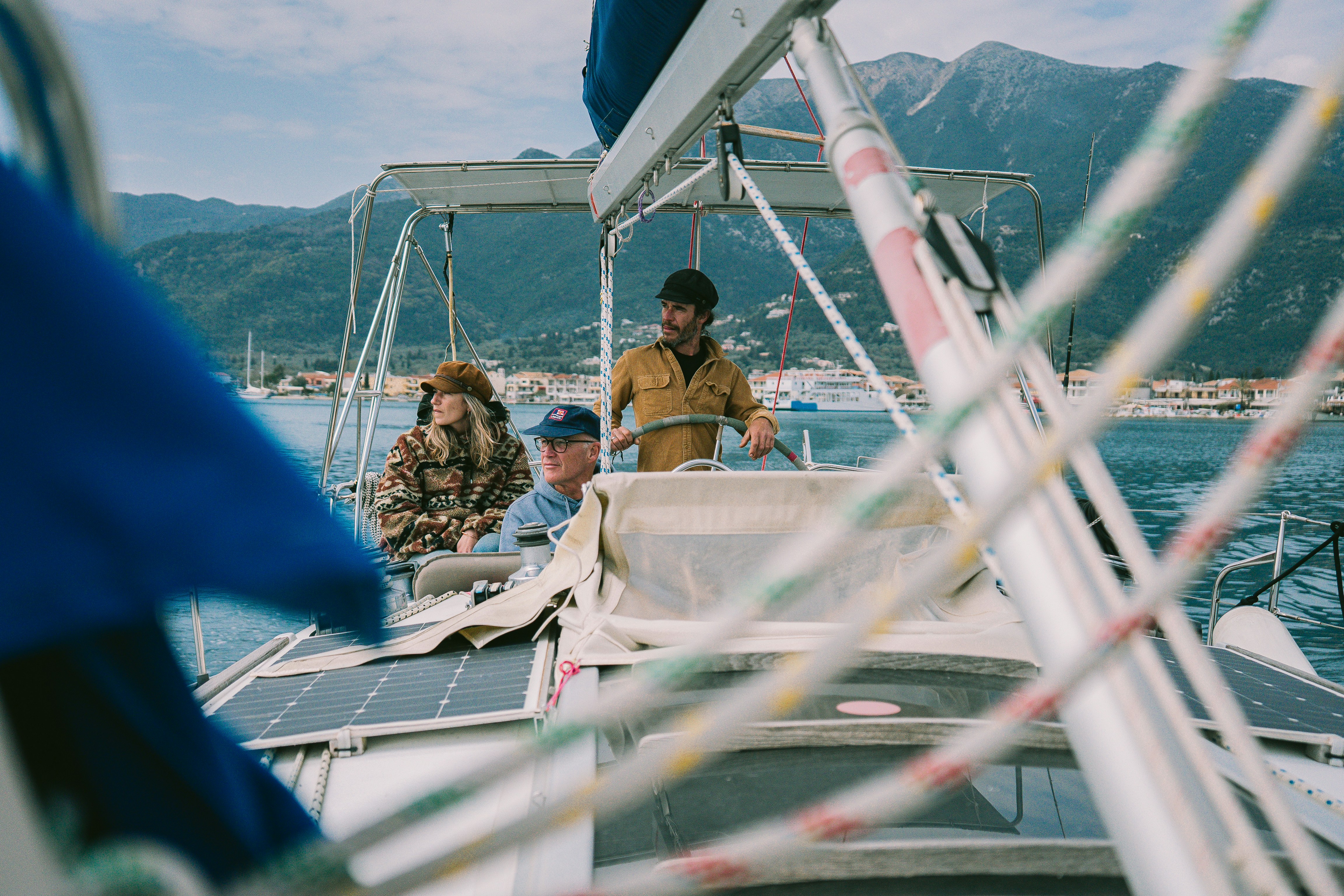 Three Seafarers on a Sunswept Charter amid Alpine Harbor