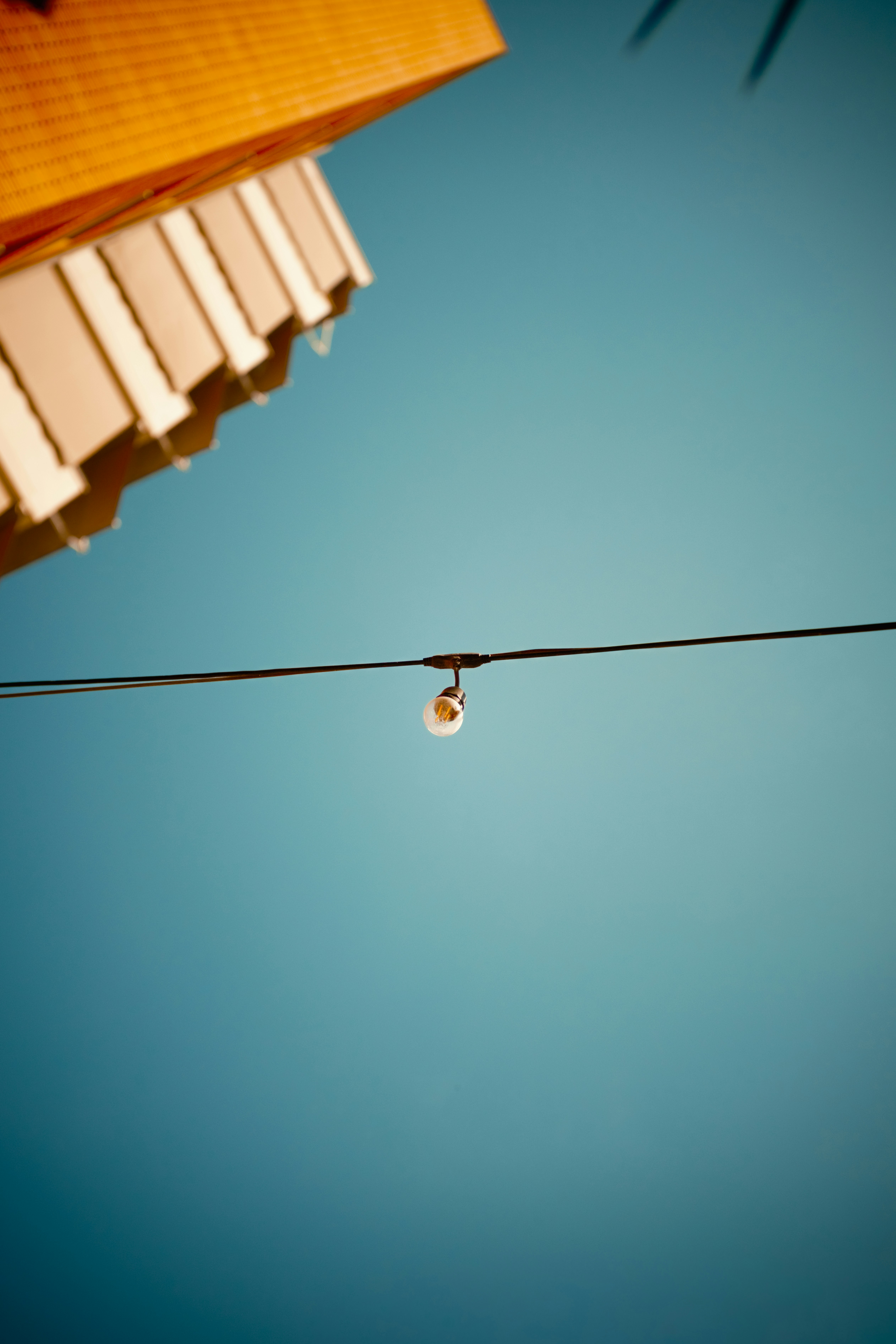 Thread of Light: A Minimal Moment Beneath a Distant Balcony