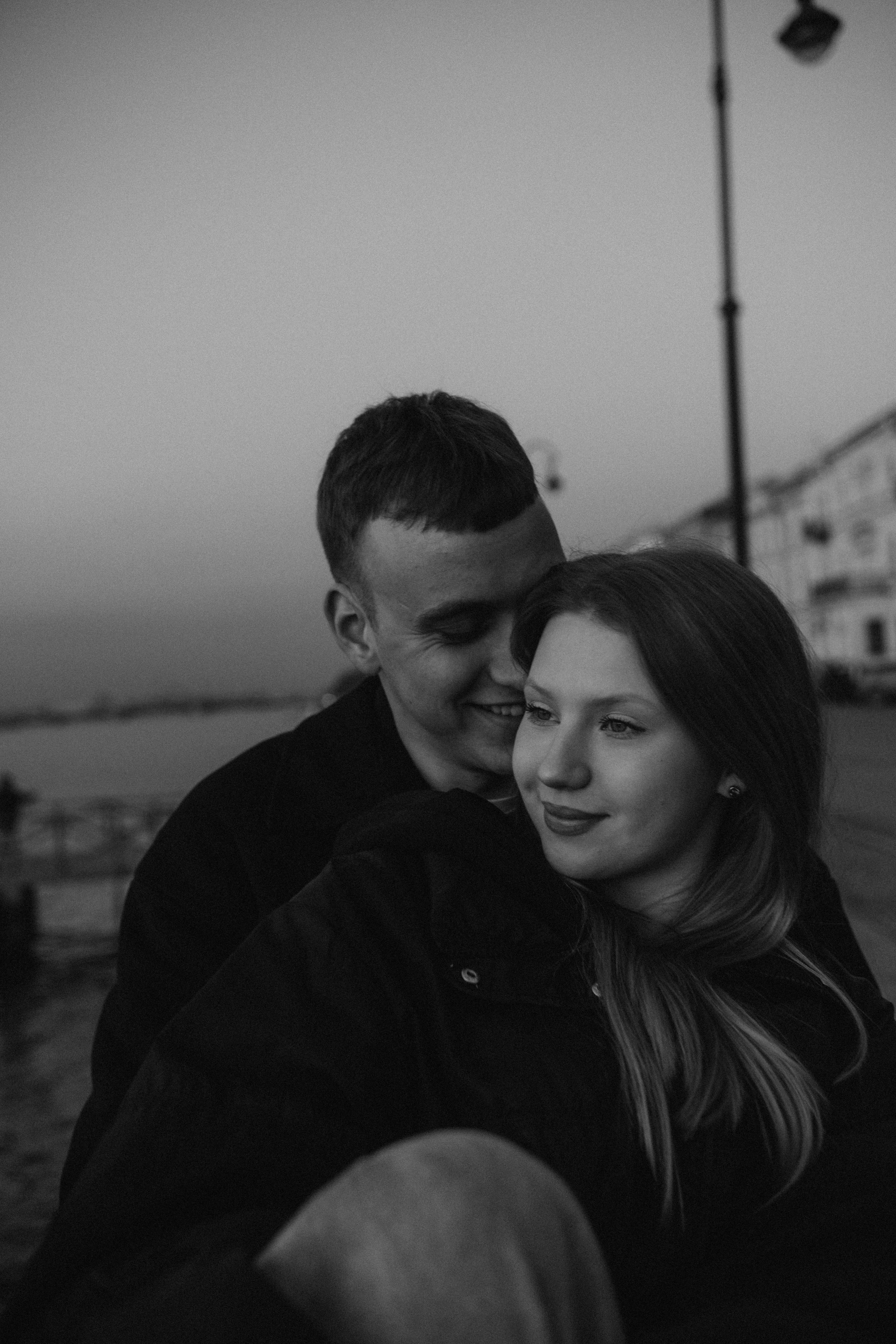 Embrace by the Pier: Quiet Close of Two Hearts