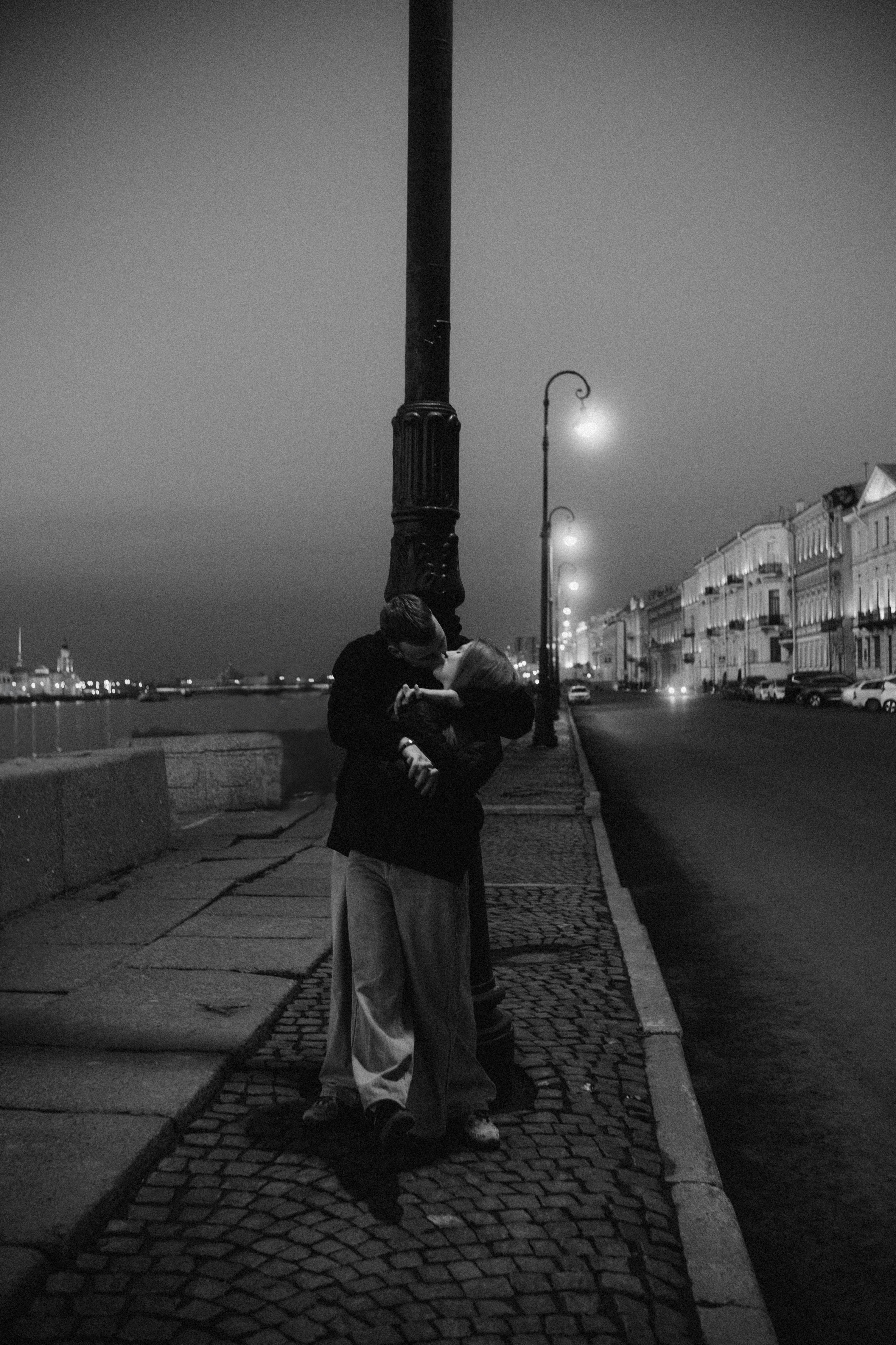 Midnight Embrace on a Waterfront Street