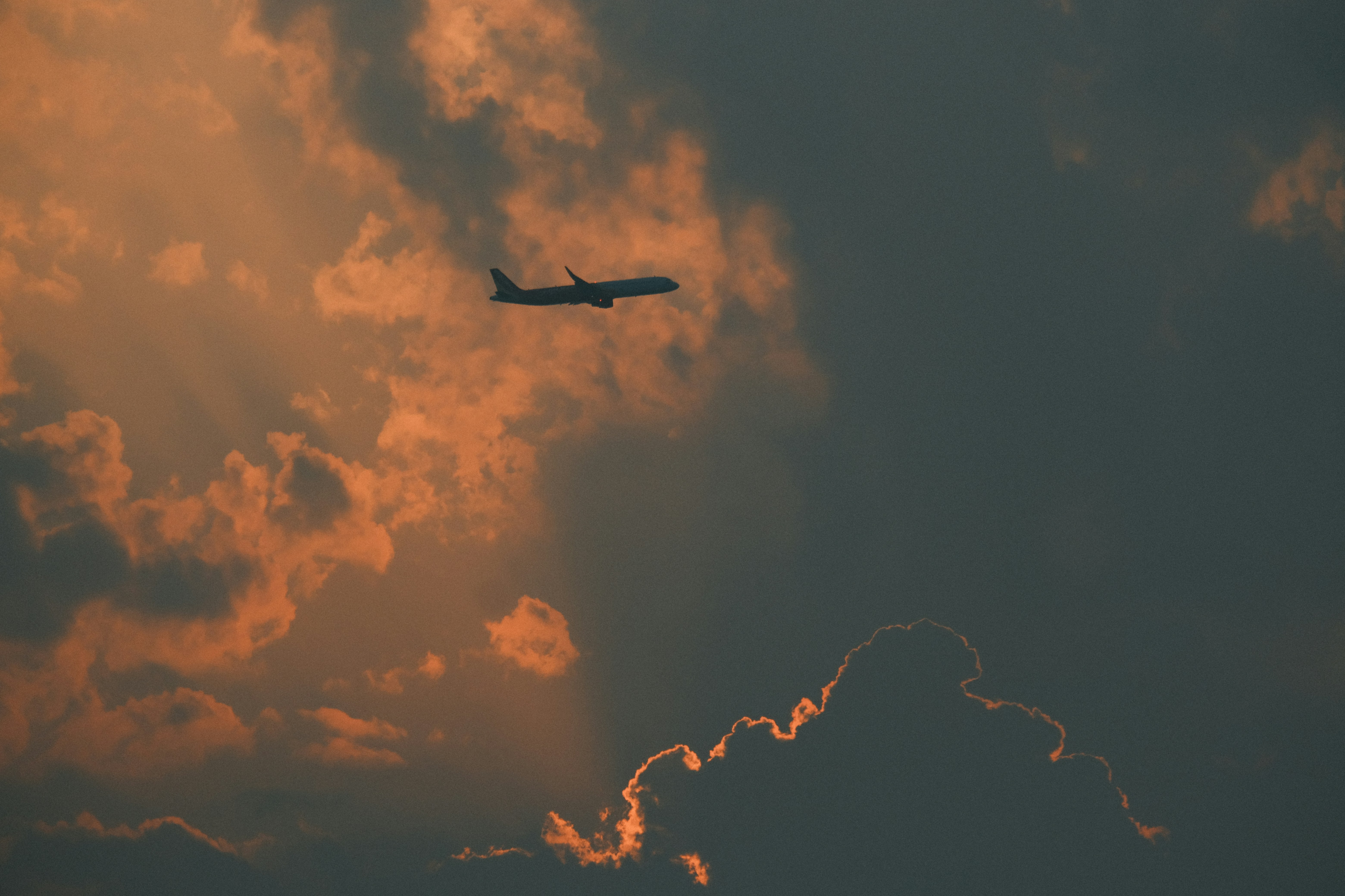 Jet Silhouette Crossing a Dawn-Worn Horizon