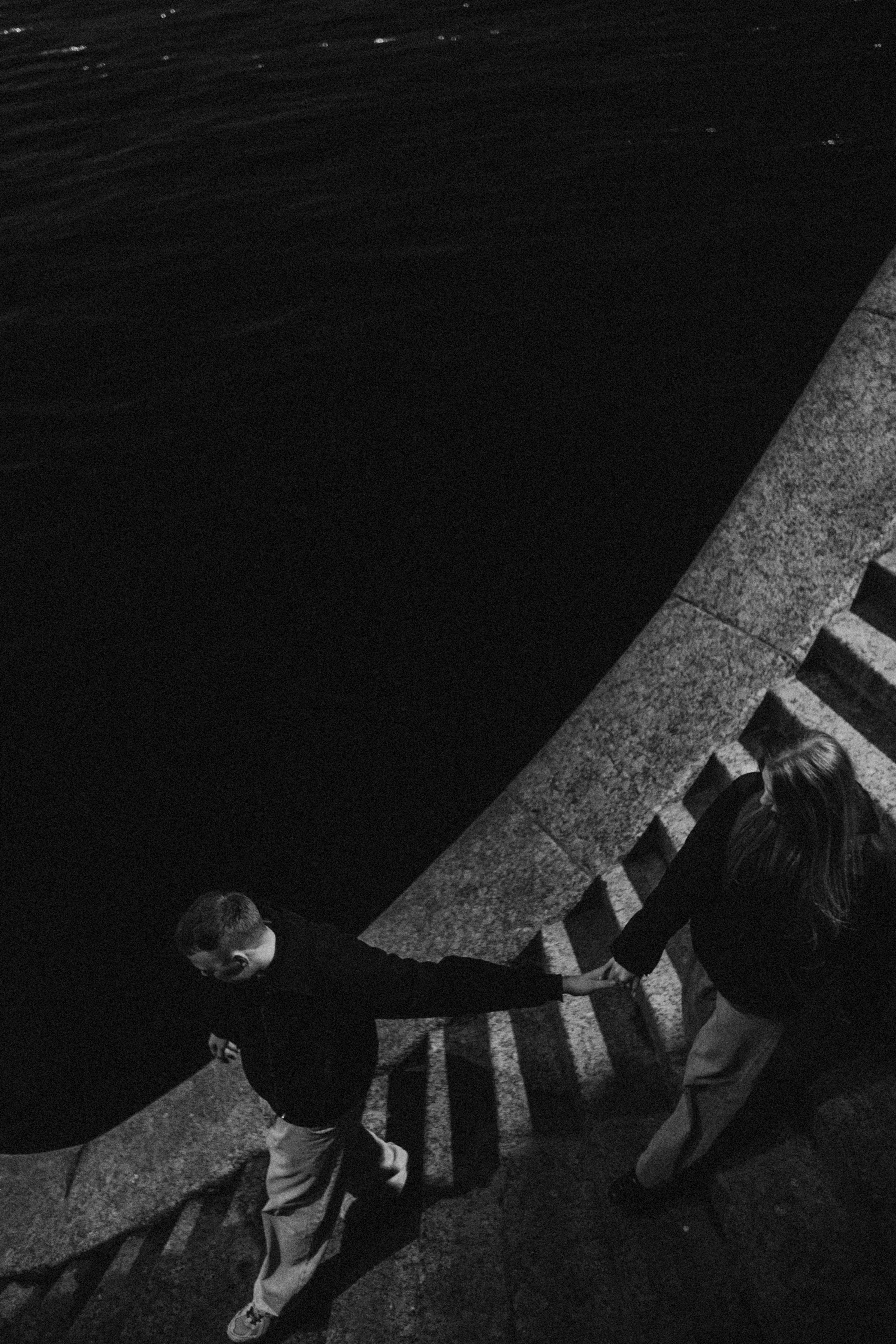 Holding Hands Over the Circular Stair: A Quiet Moment on the Edge