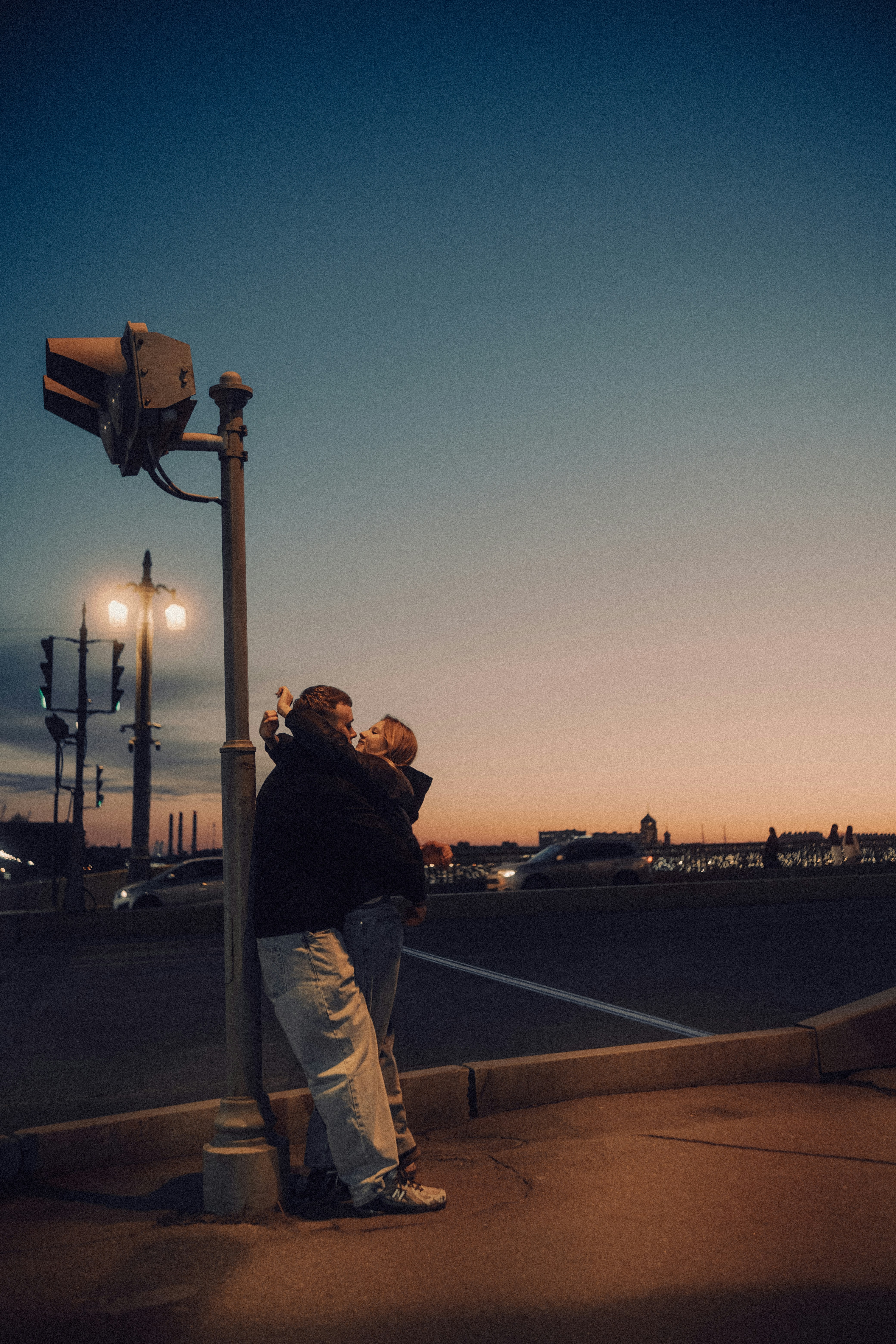 Embrace at Sunset: A Kiss by the Pier Lamp