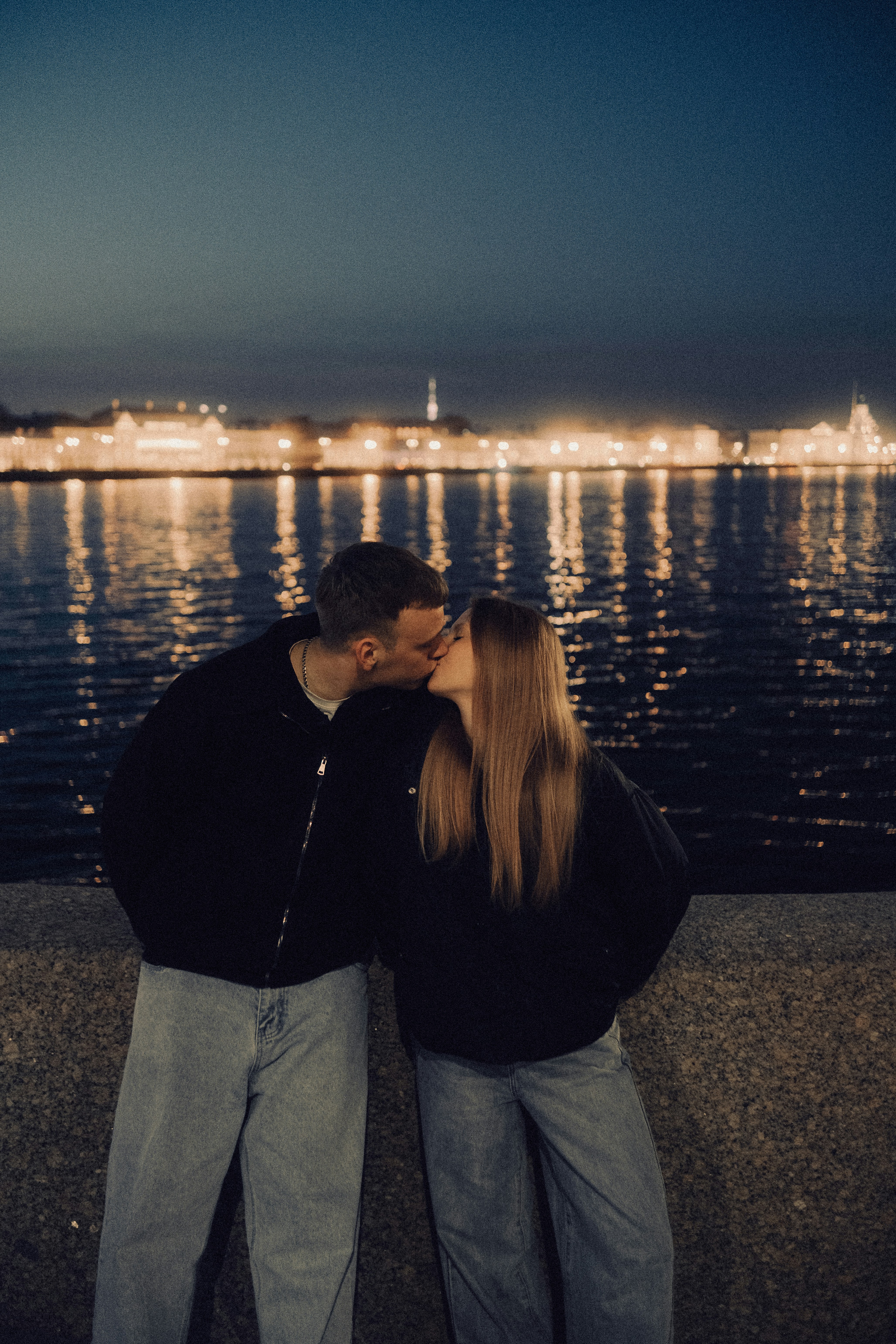 Kiss by the Waterfront: Night Glow Over the Harbor