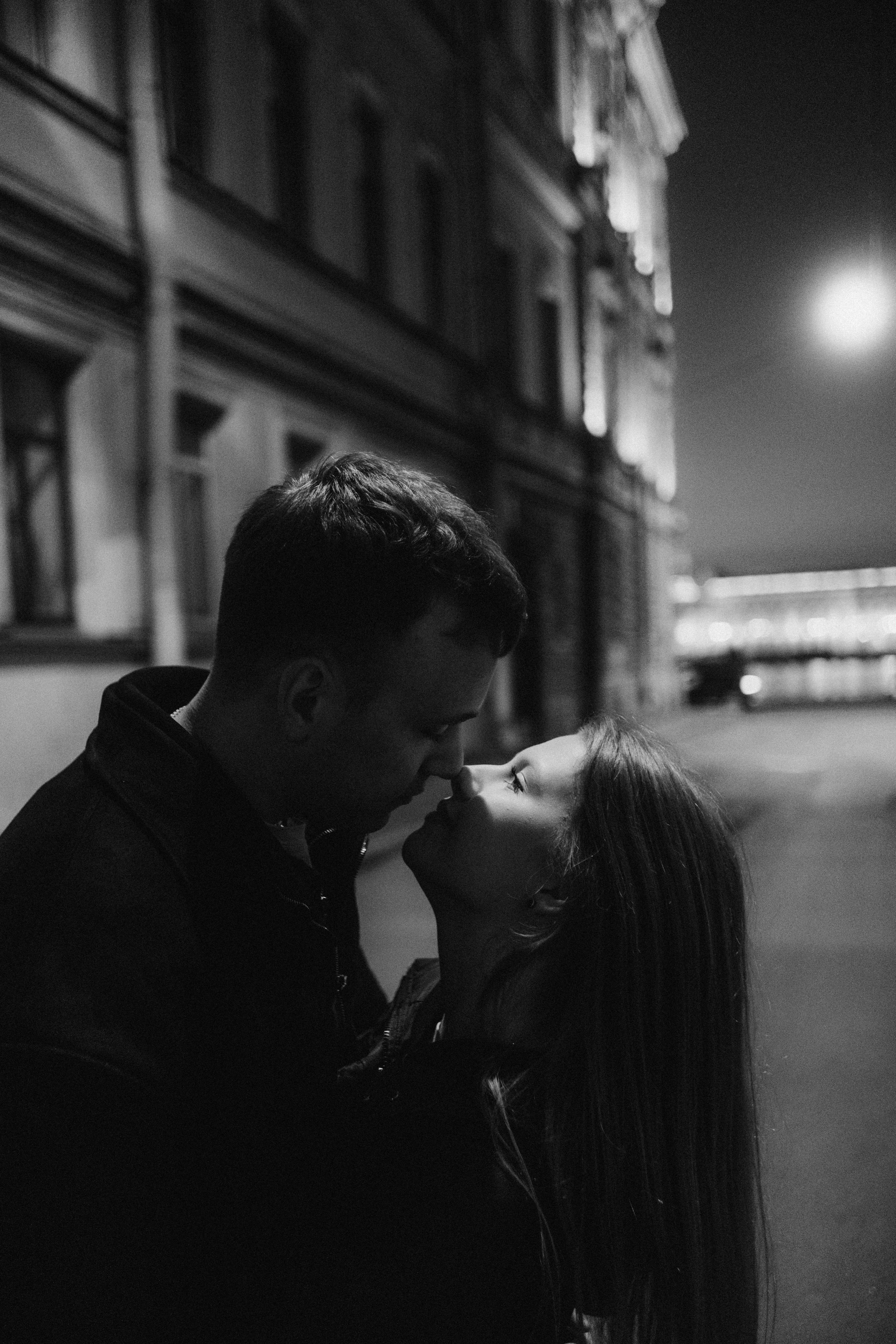 Moonlit kiss on a city street