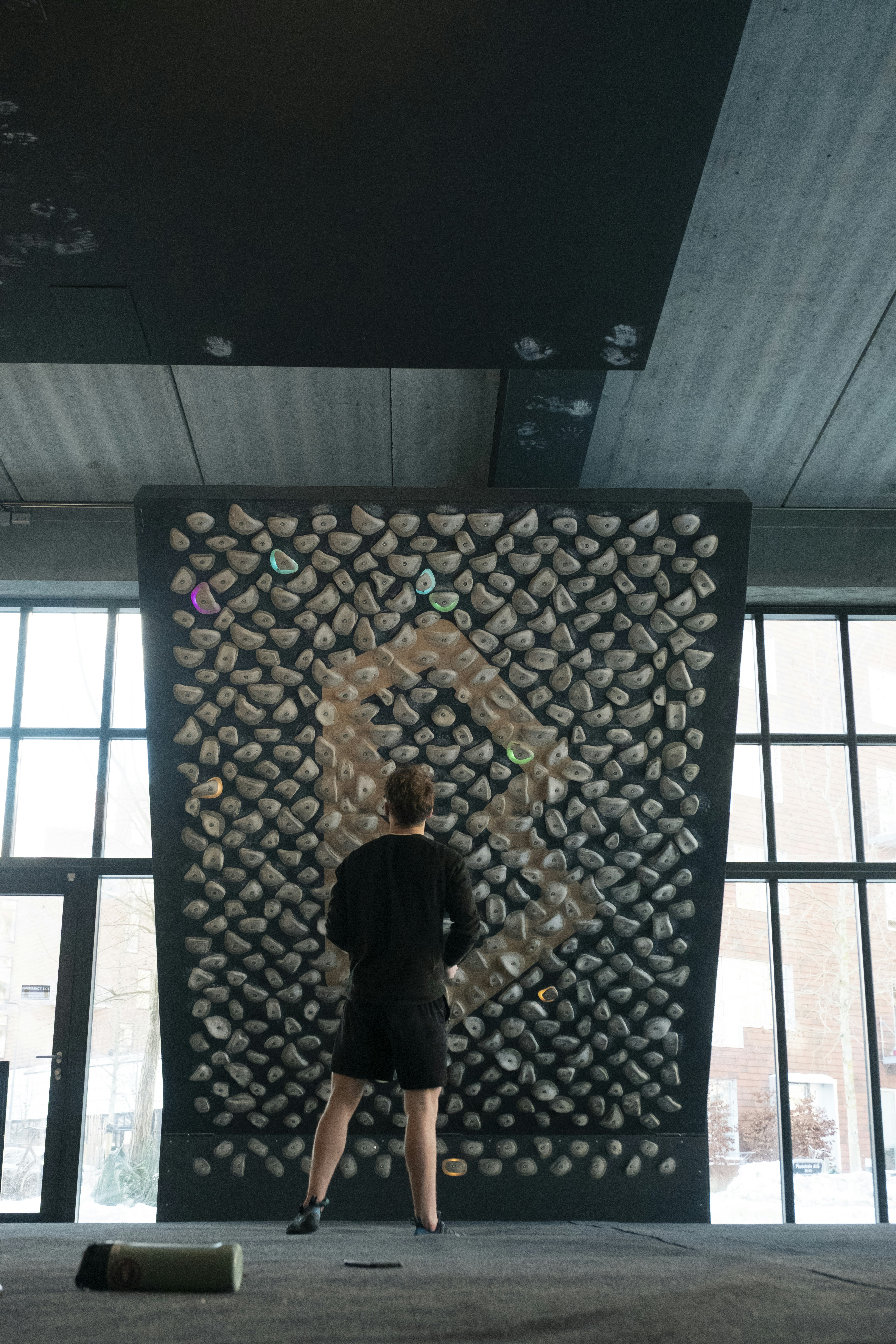 The Climber's Path: A lone figure confronting the textured rock wall