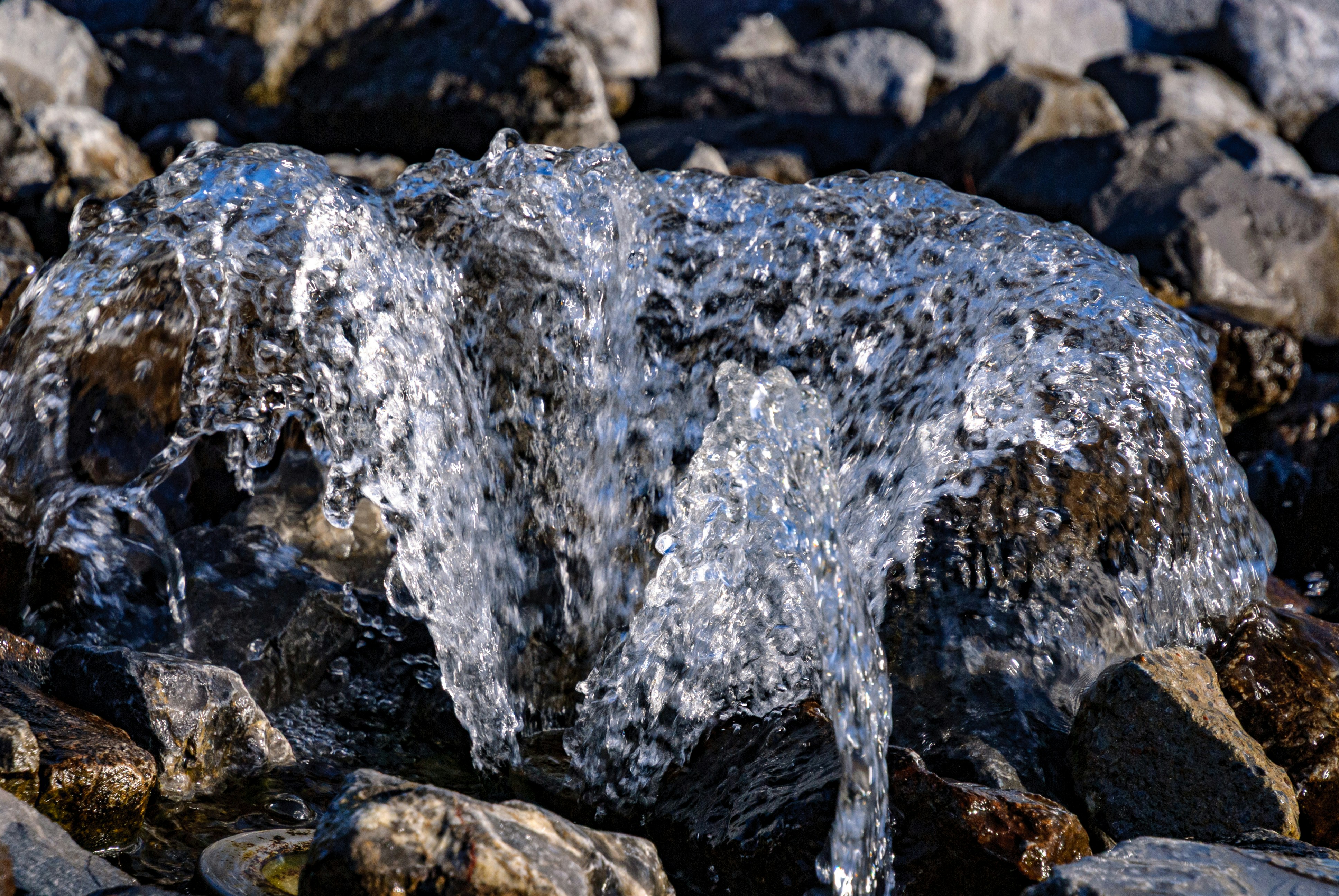 Ice-Glint Cascade over Weathered Stones