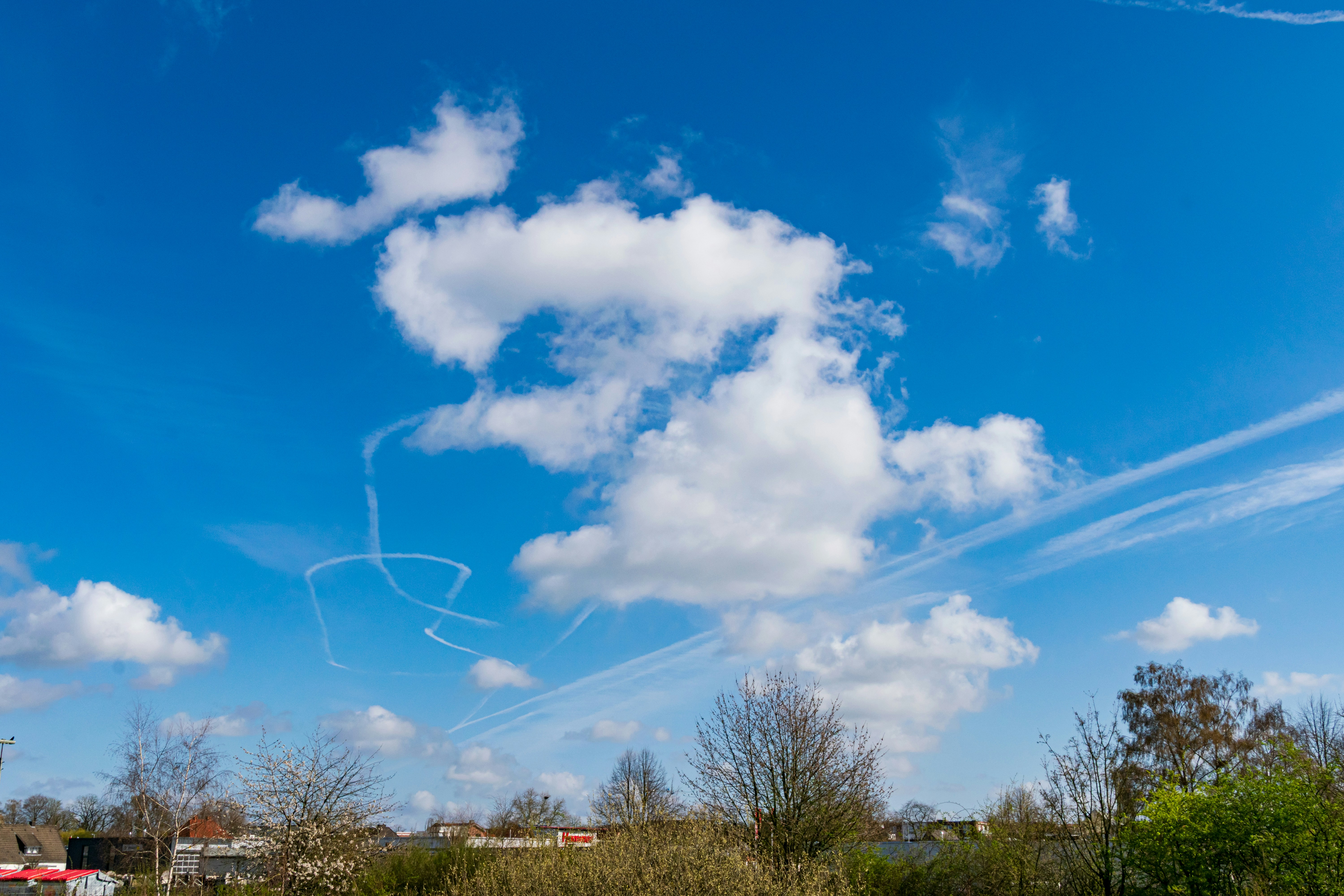 Cumulus Whispers Across a Clear Spring Sky