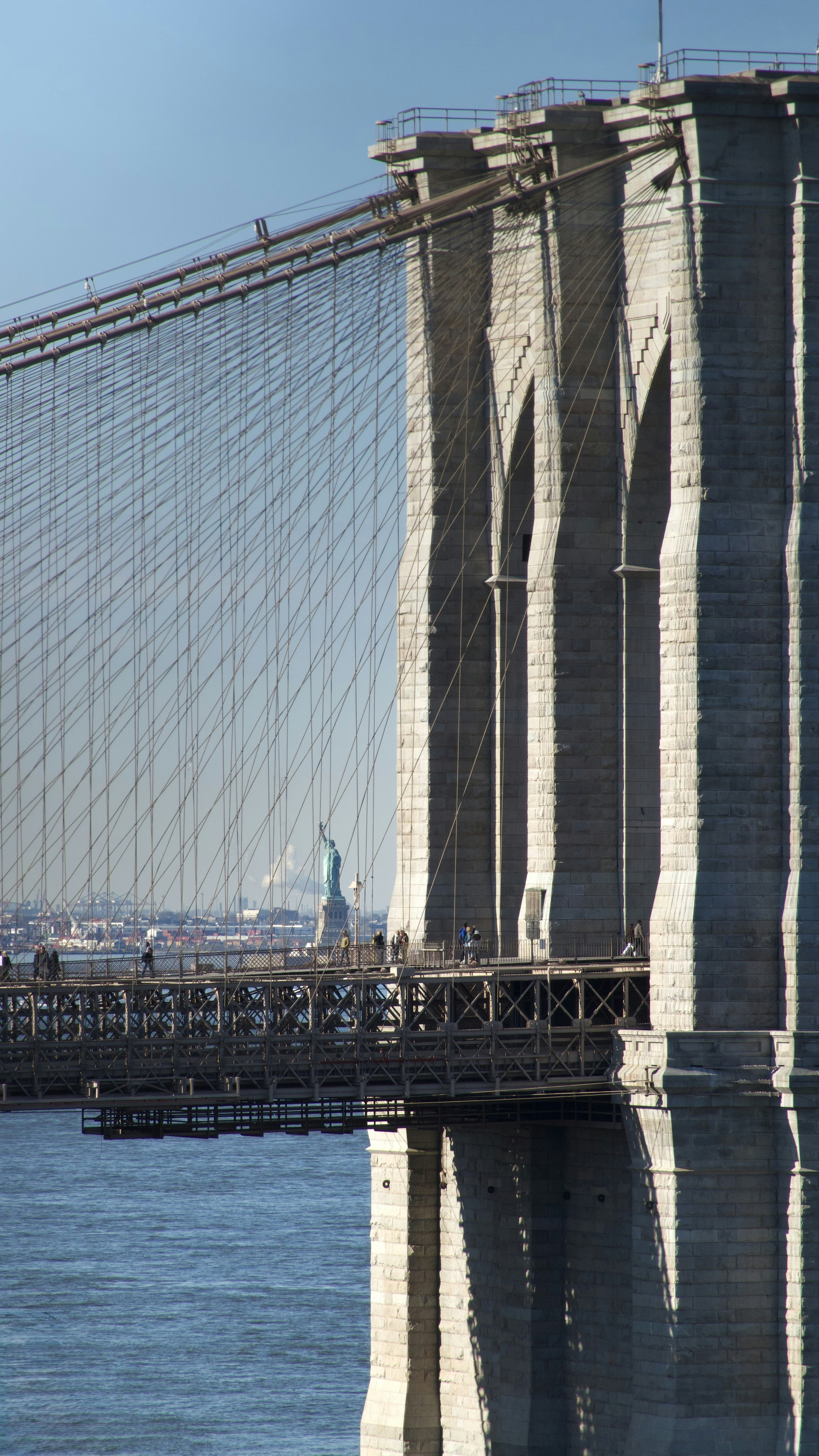 Across the Span: Towering Cables and Stone in Long Shadow