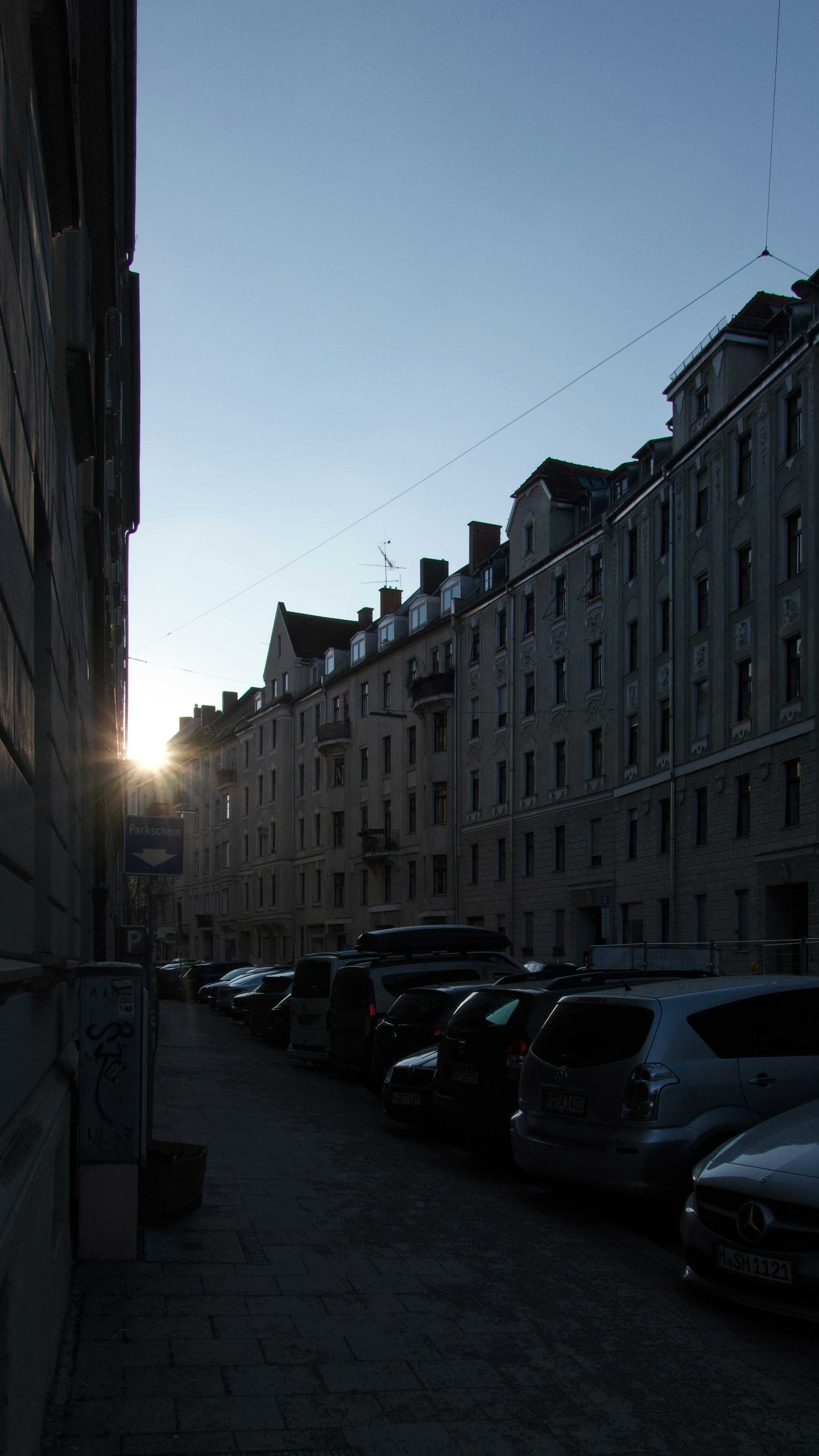 Sunlit Narrow Street Between City Facades