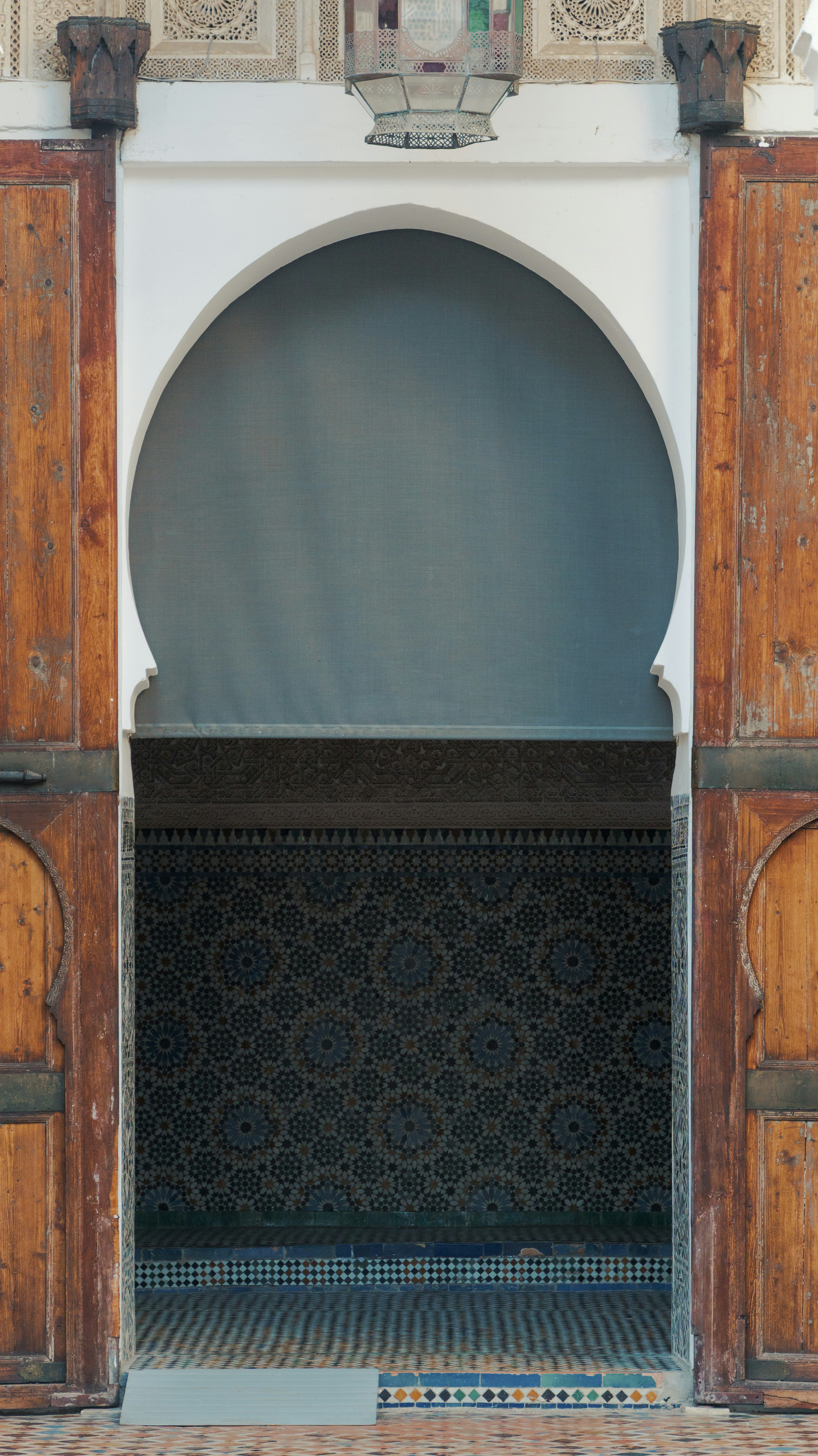 Arched Portal with Mosaic Frieze and Weathered Doors